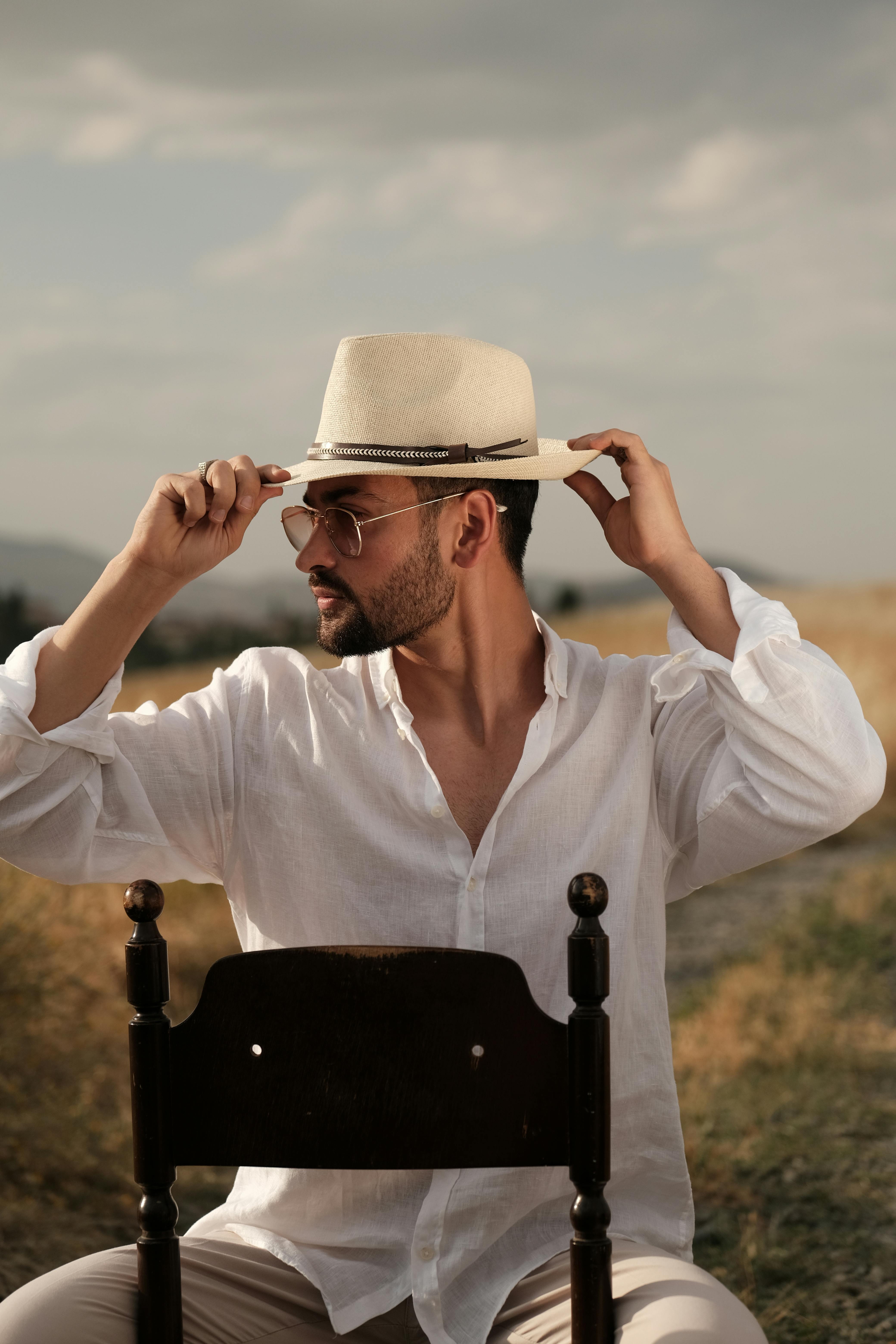 Model Adjusting His Hat · Free Stock Photo