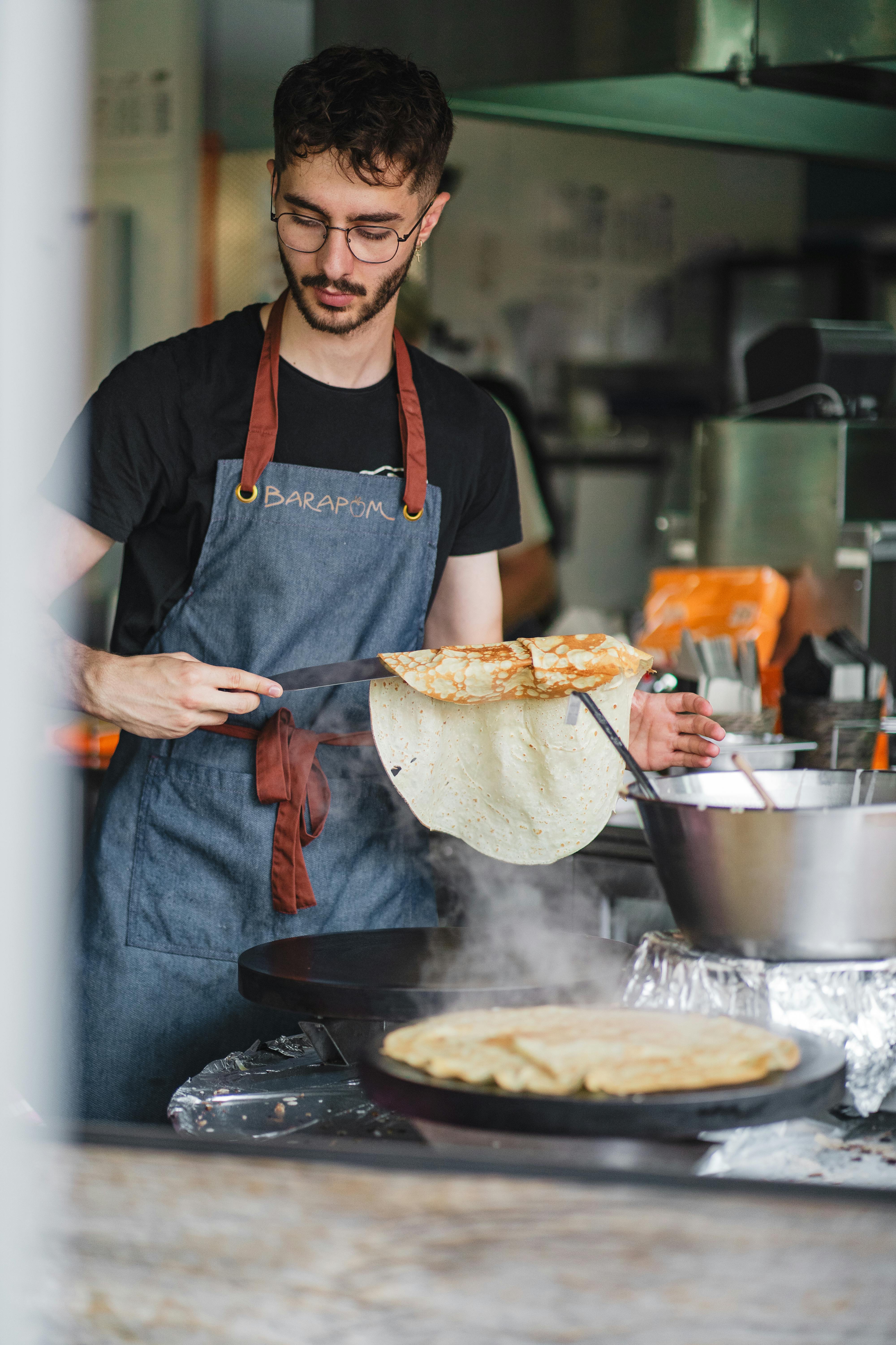 Man Making Pancakes in a Kitchen · Free Stock Photo