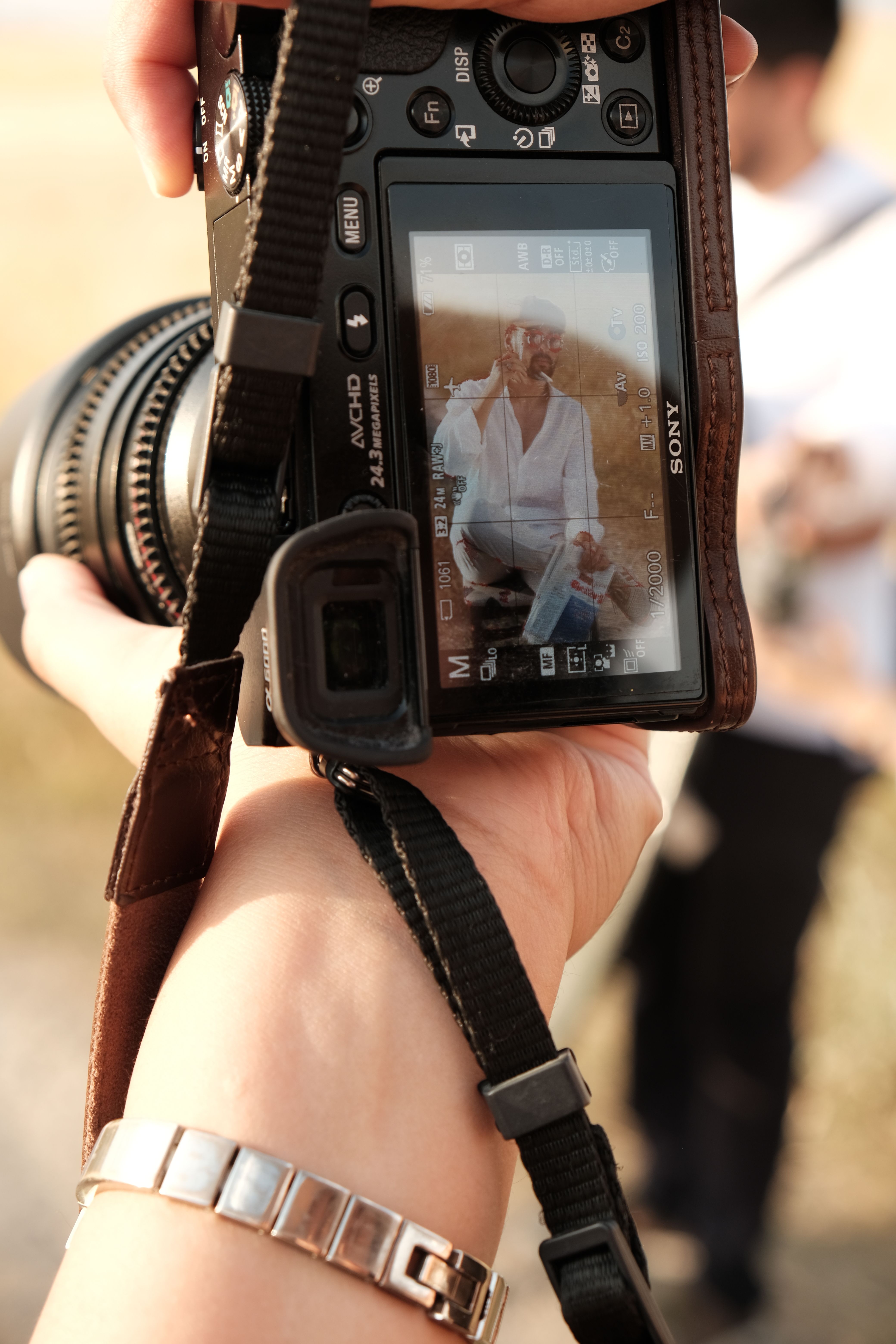 Sony Camera with AVCHD Format with Man Sitting on a Field on Preview ...