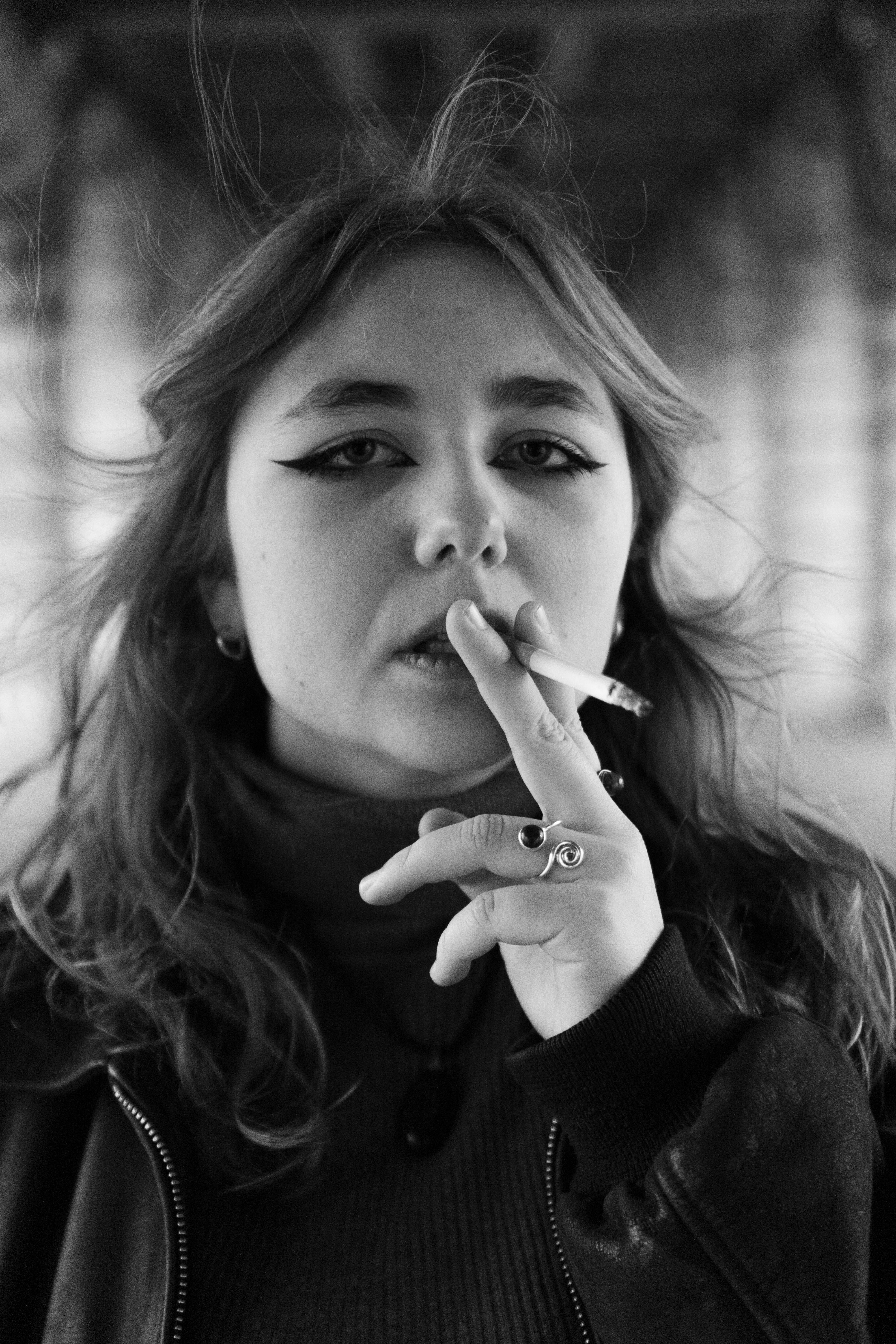 Stylish woman smoking near wall · Free Stock Photo