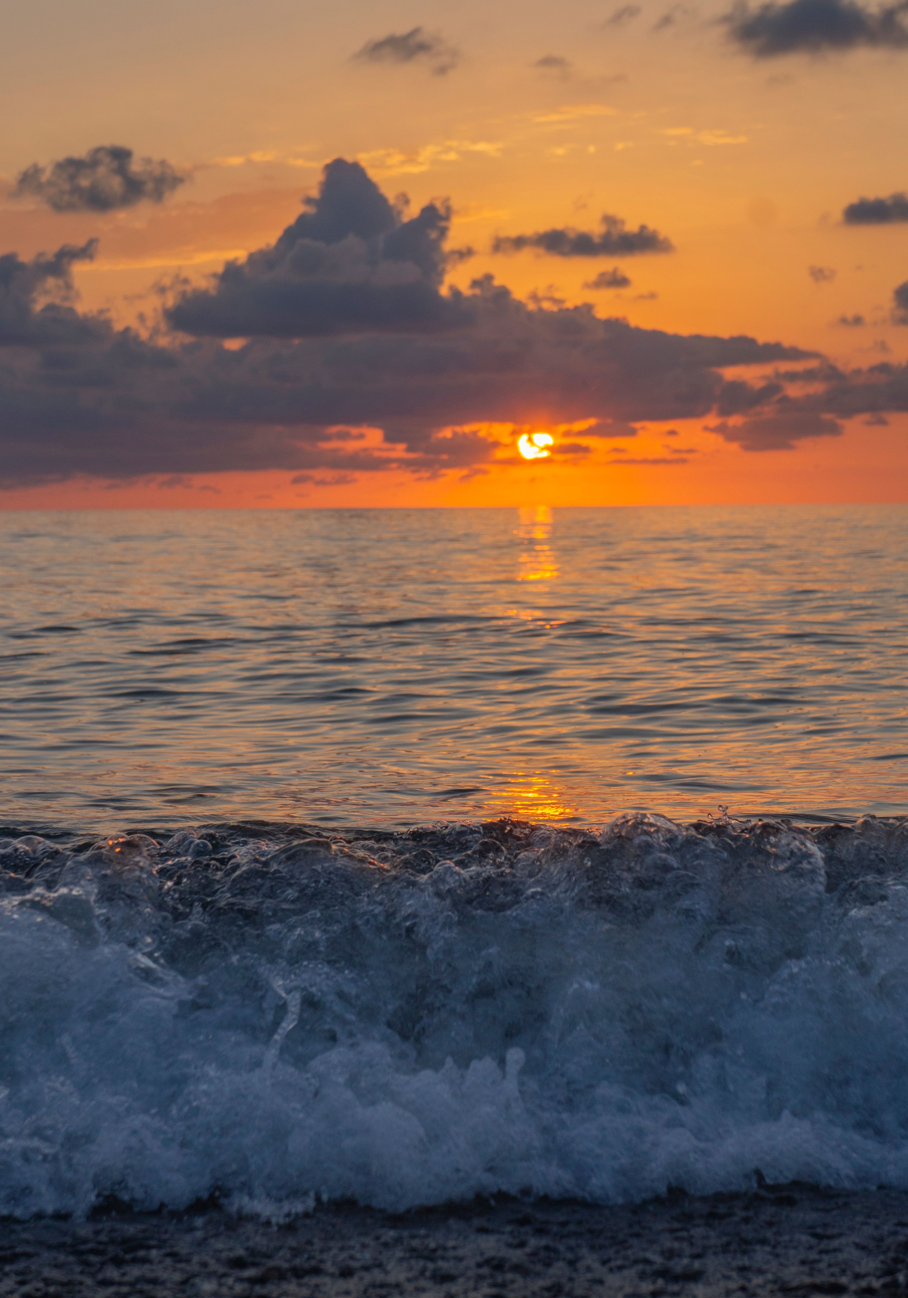 Wave Breaking on Beach at Sunset · Free Stock Photo