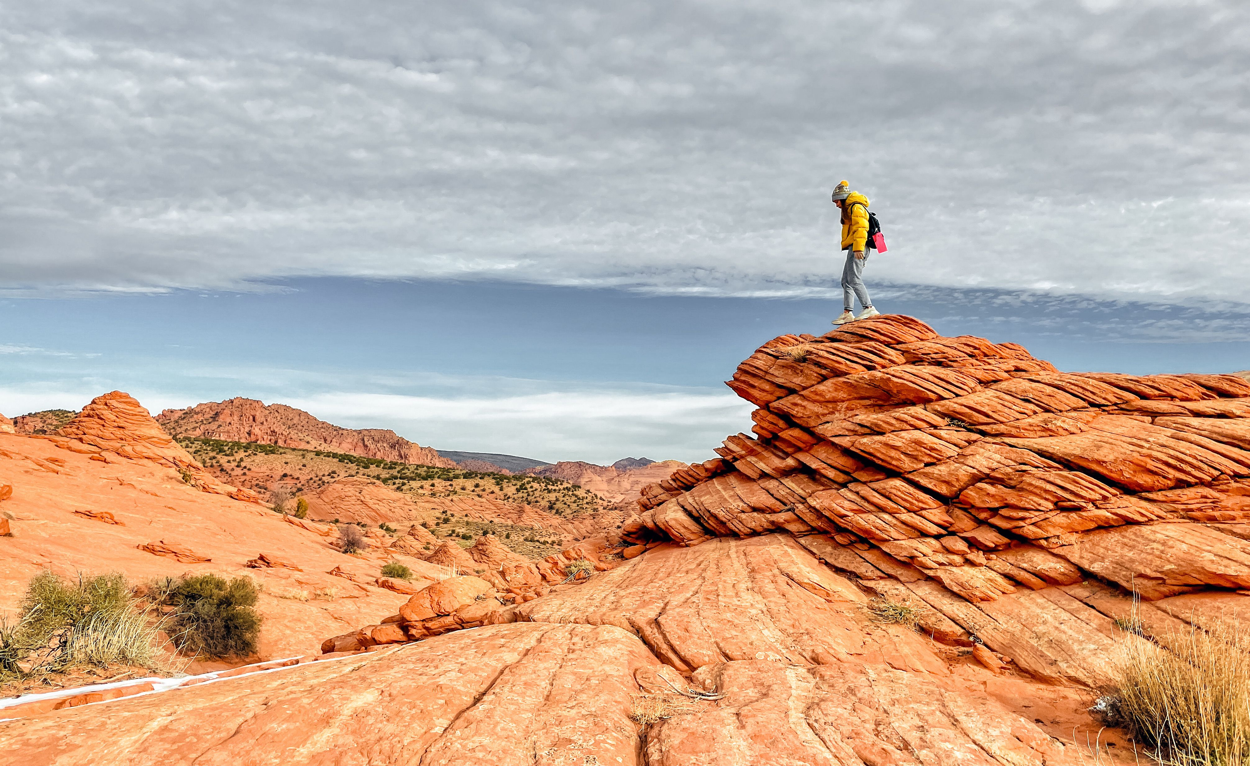 Backpacker on Rock Formation in Desert · Free Stock Photo