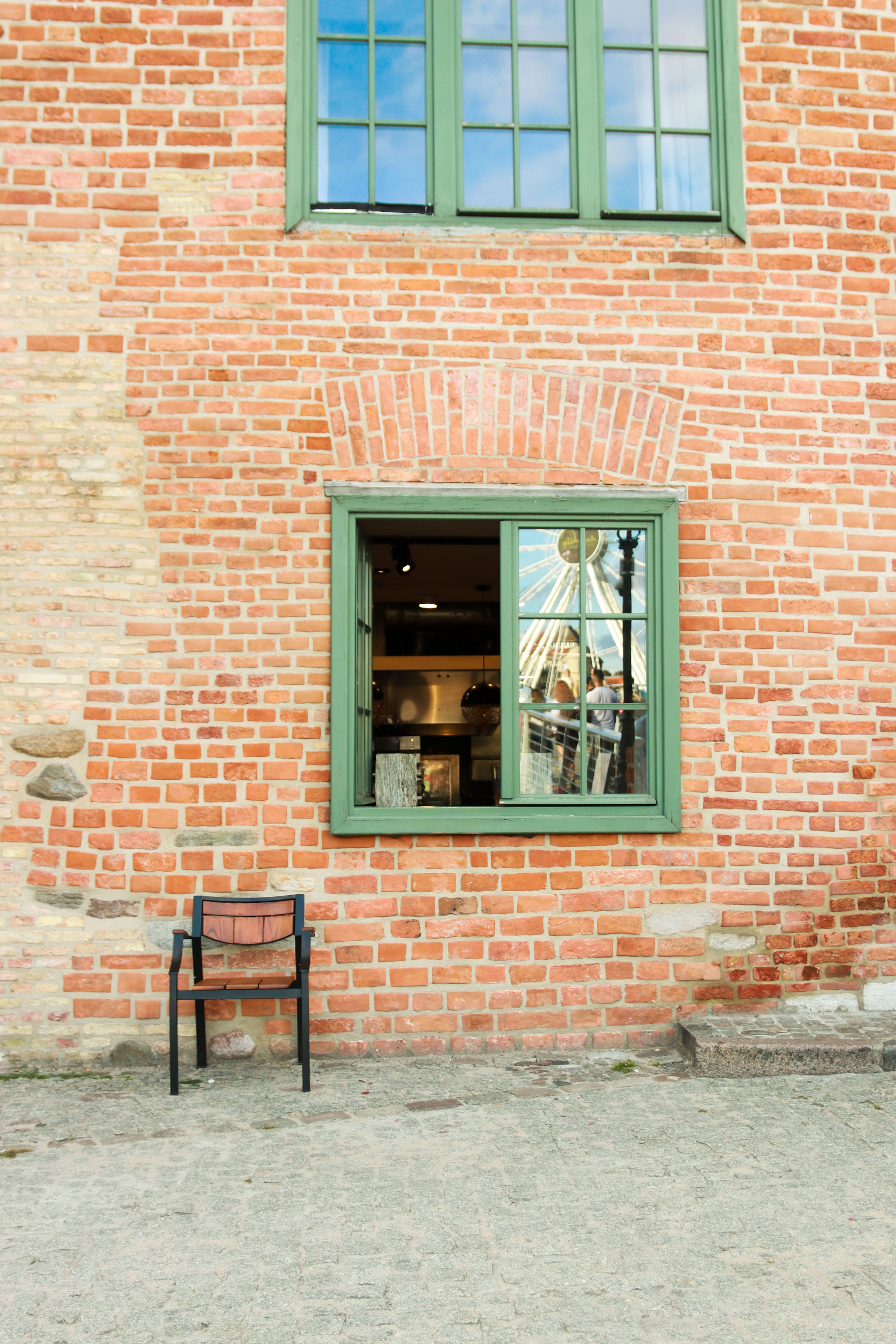 Chair Under the Restaurant Kitchen Window Reflecting Tourists Going to ...