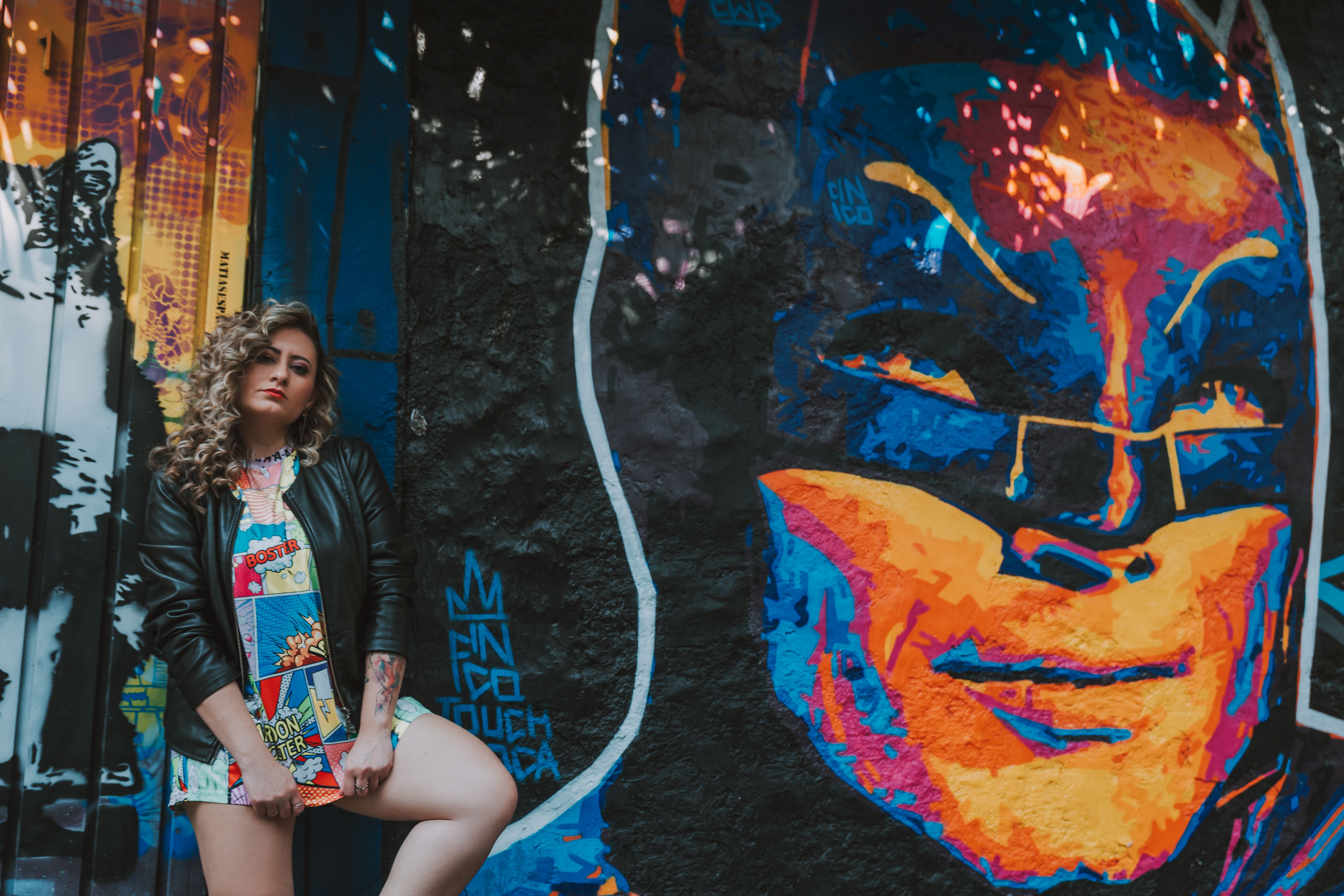 Man in T-Shirt and Jeans Standing by Mural on Wall · Free Stock Photo
