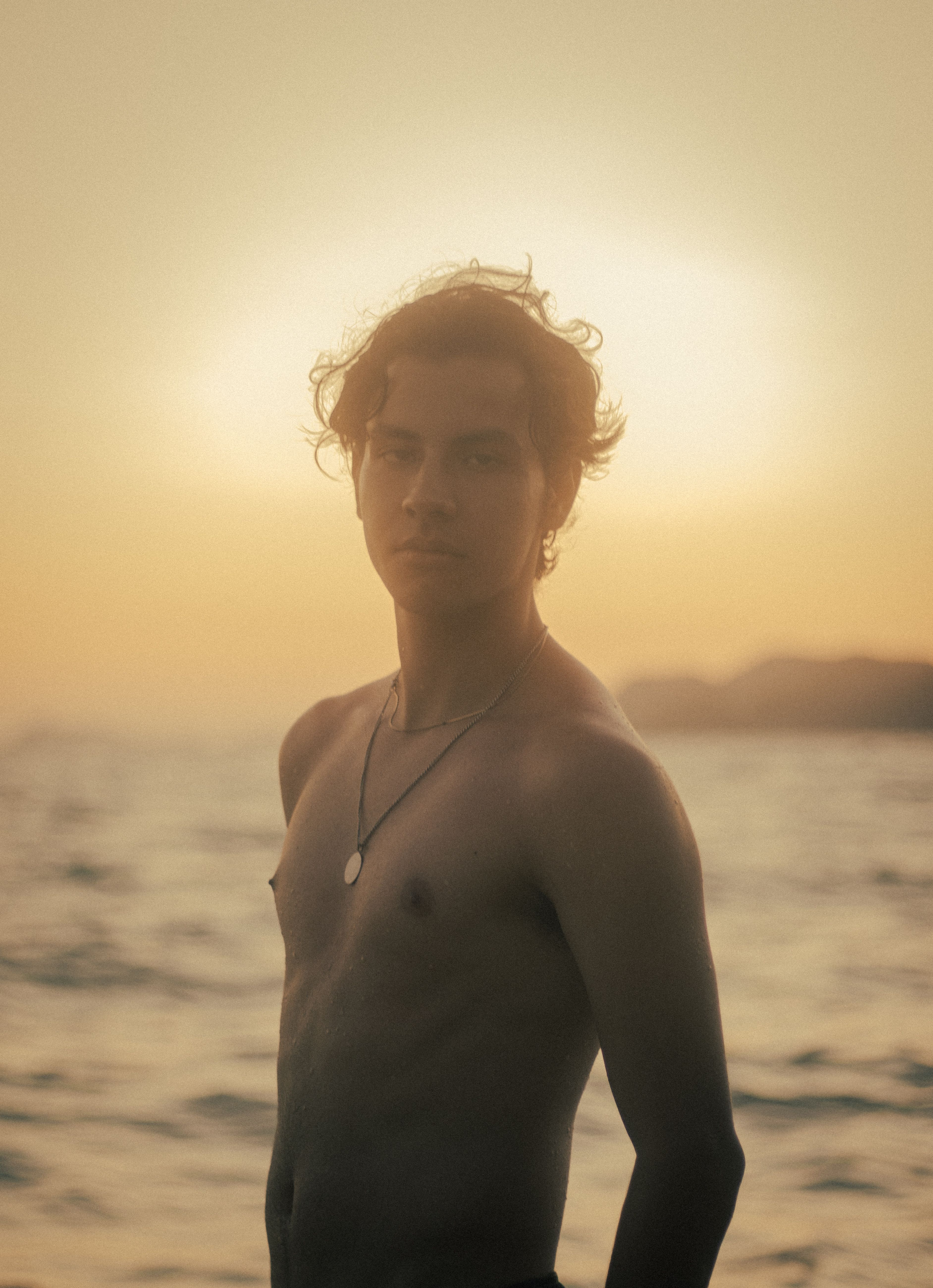 Shirtless Young Man By The Sea In The Light Of The Setting Sun · Free