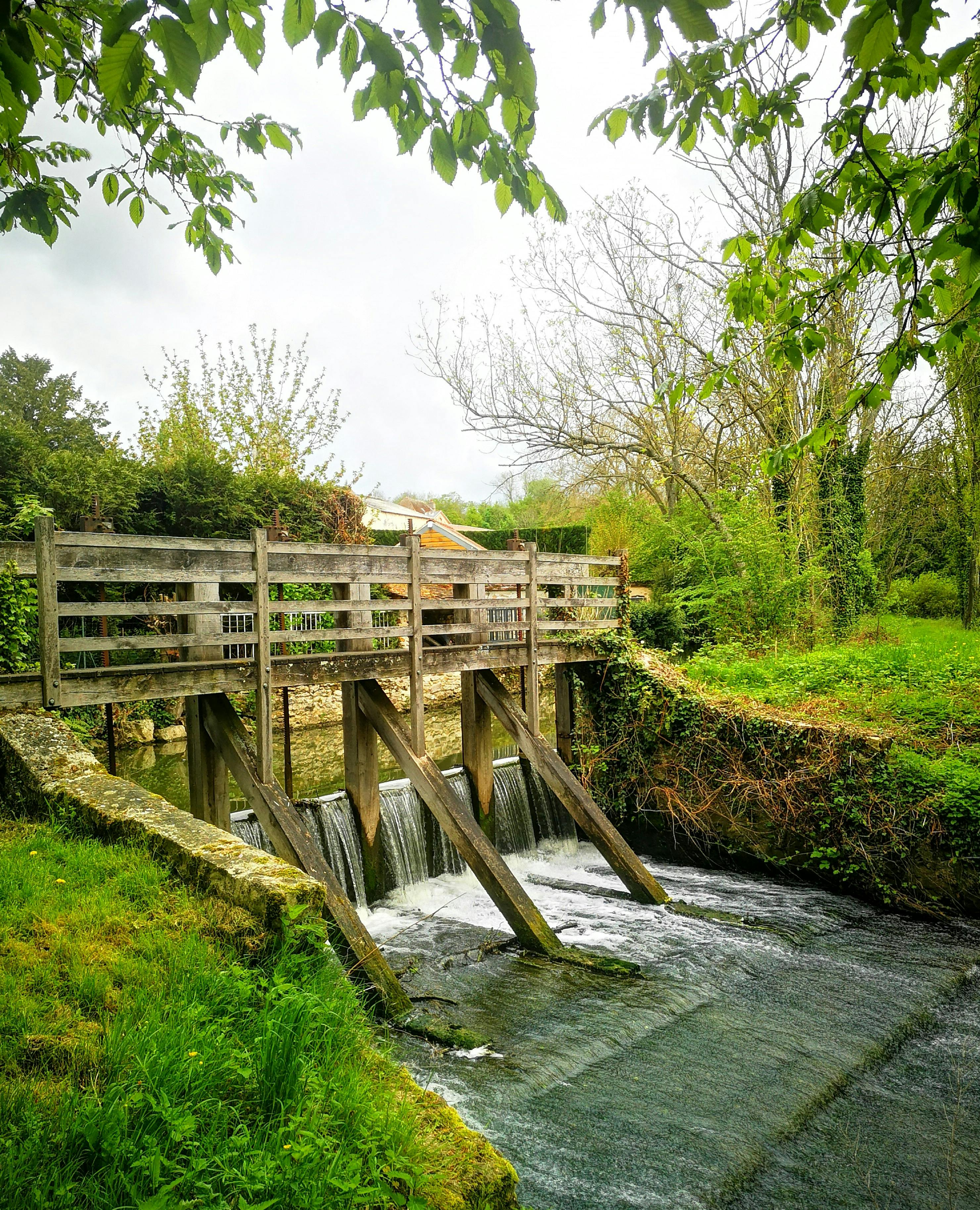 Wooden Footbridge and Dam on a River · Free Stock Photo