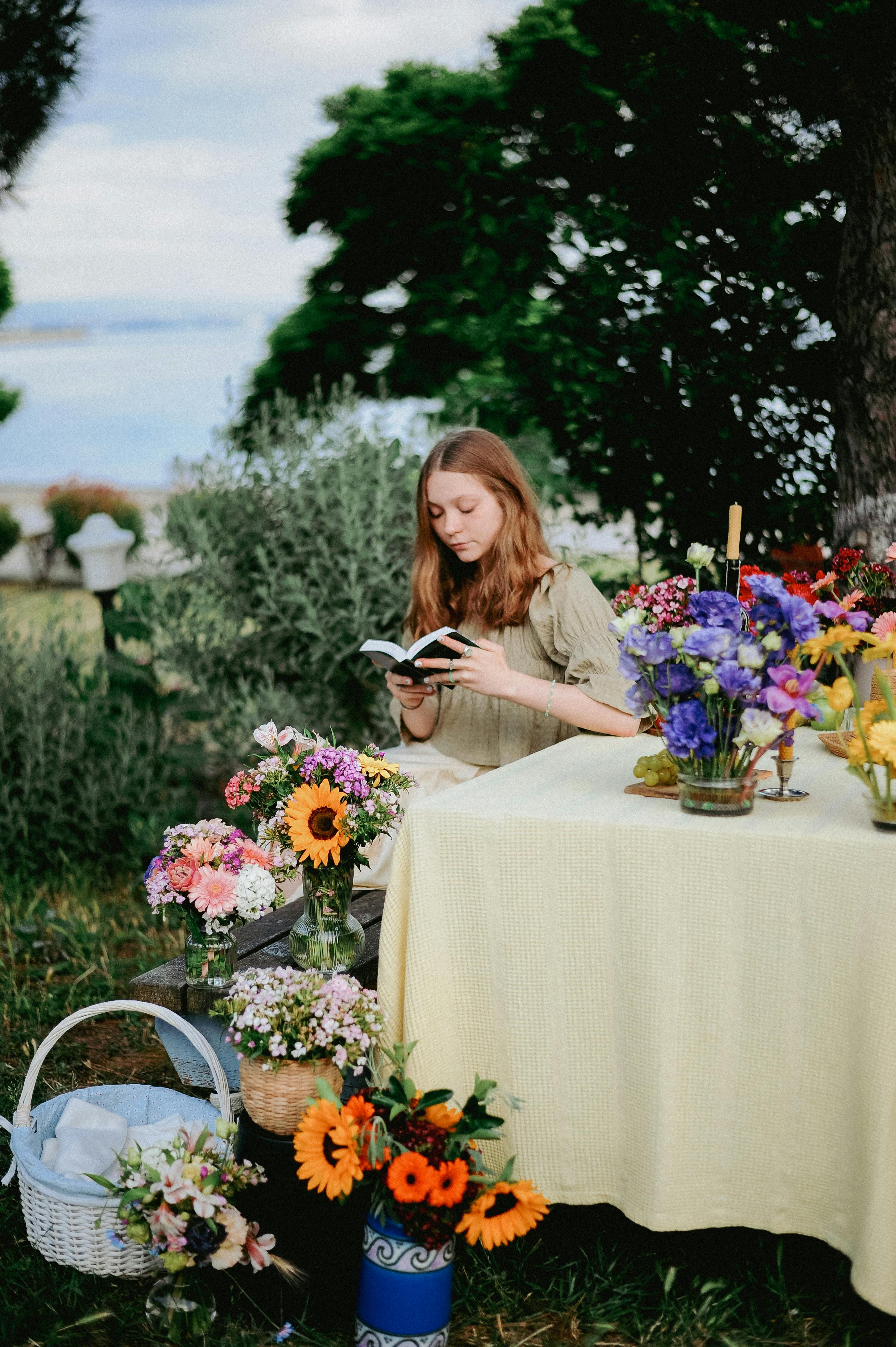 Woman Reading among Flowers · Free Stock Photo