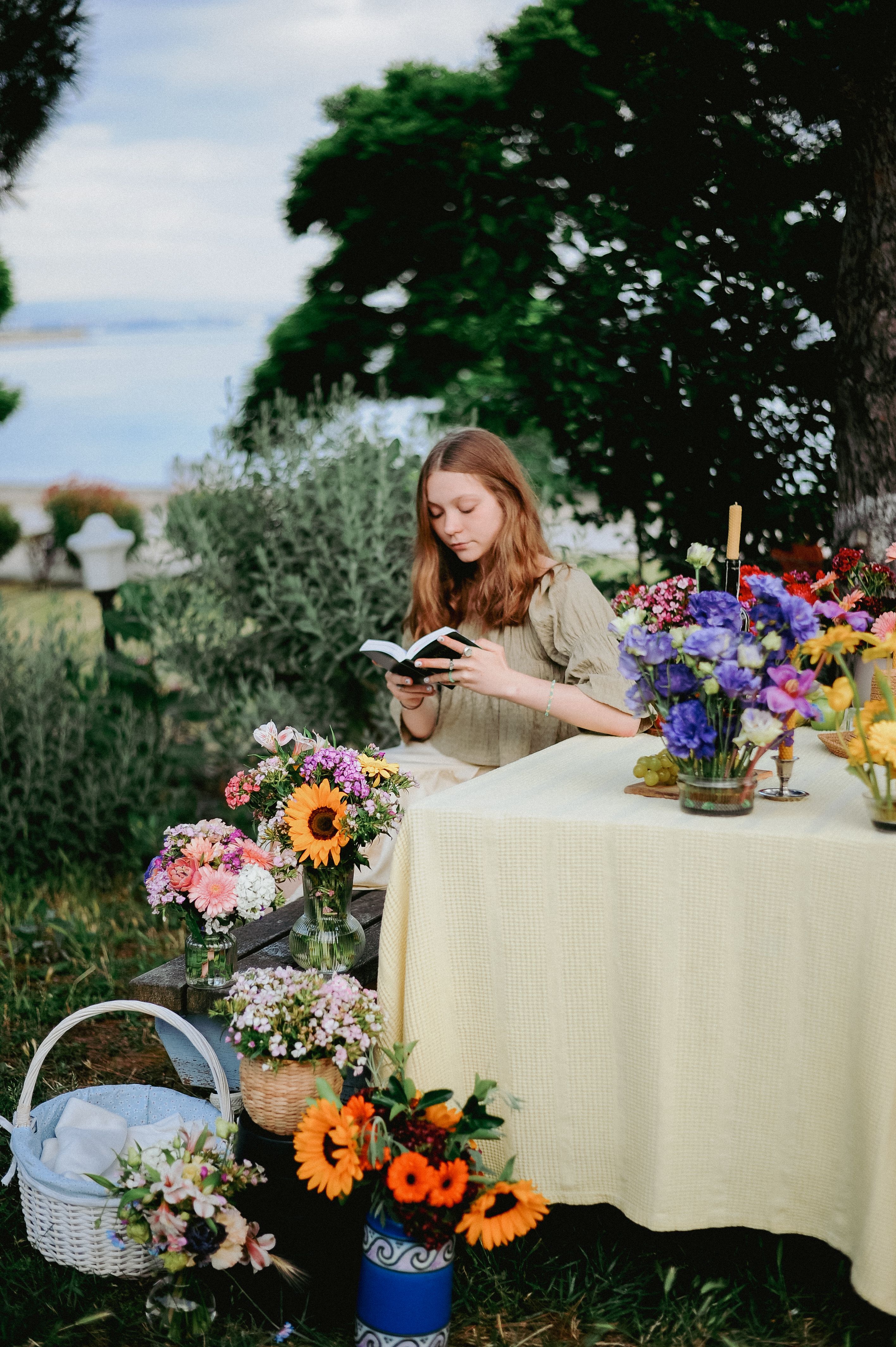 Woman Reading among Flowers · Free Stock Photo