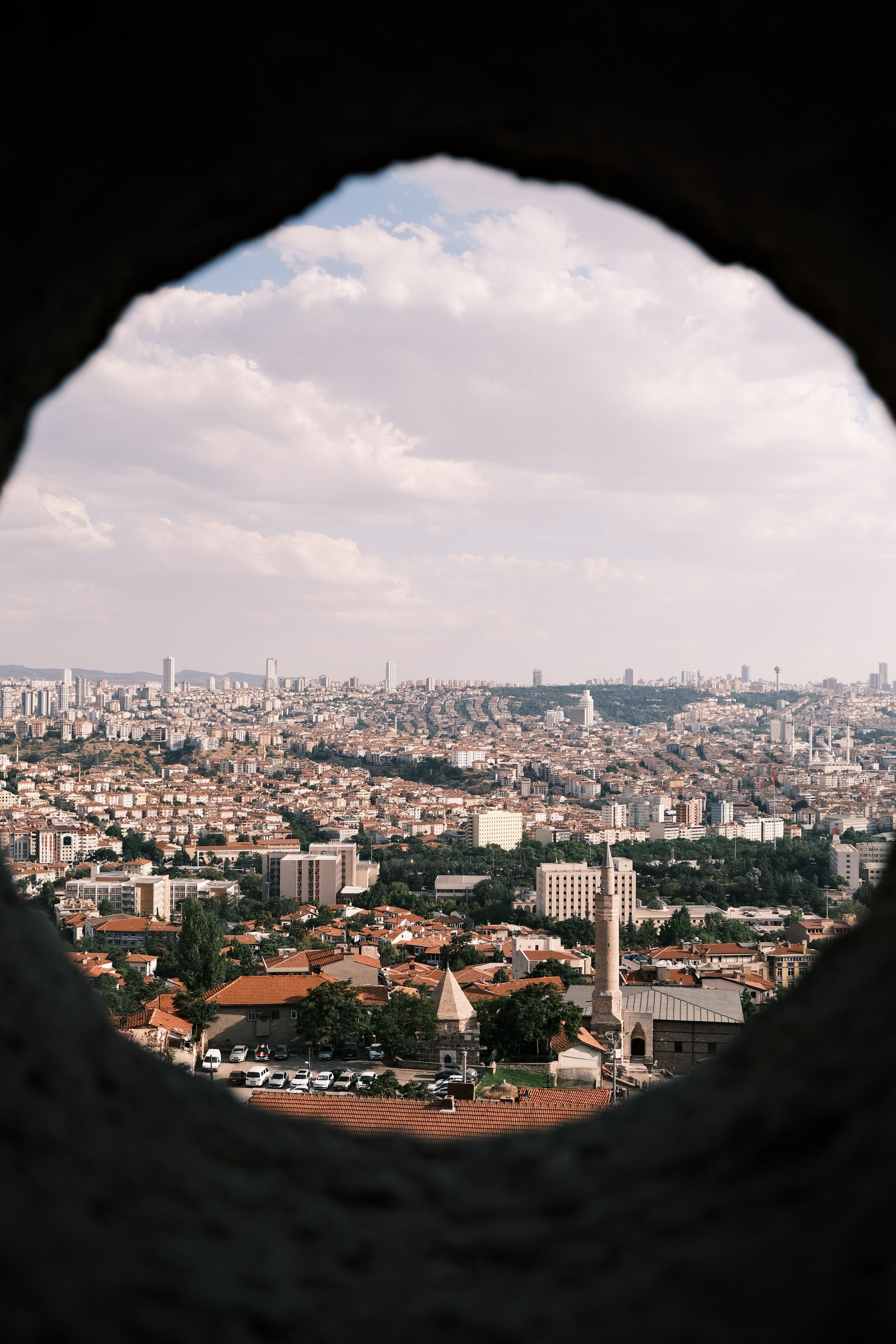 View of City through Hole in Wall · Free Stock Photo