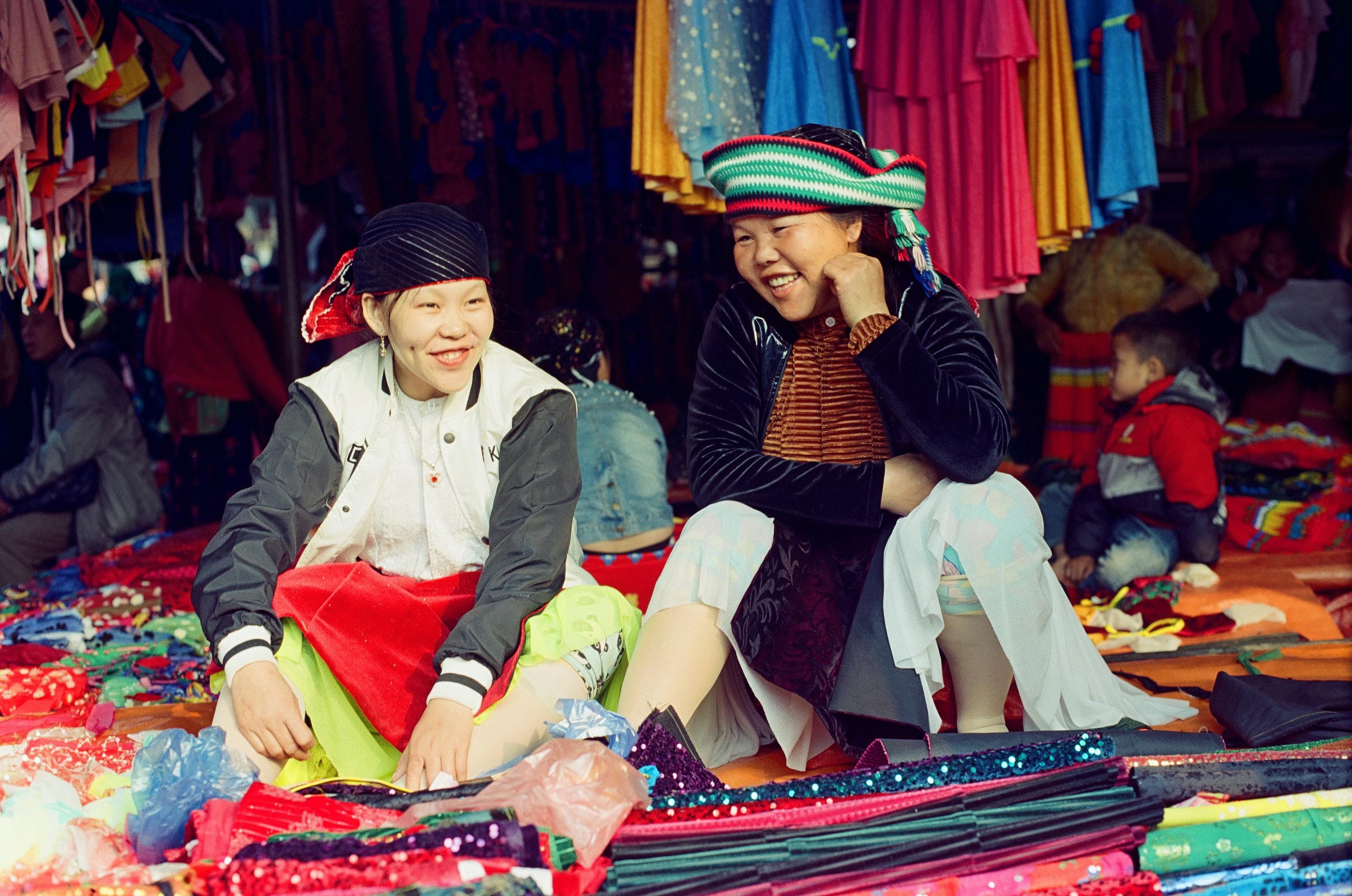 Smiling Women in Clothes Store on Street Market · Free Stock Photo