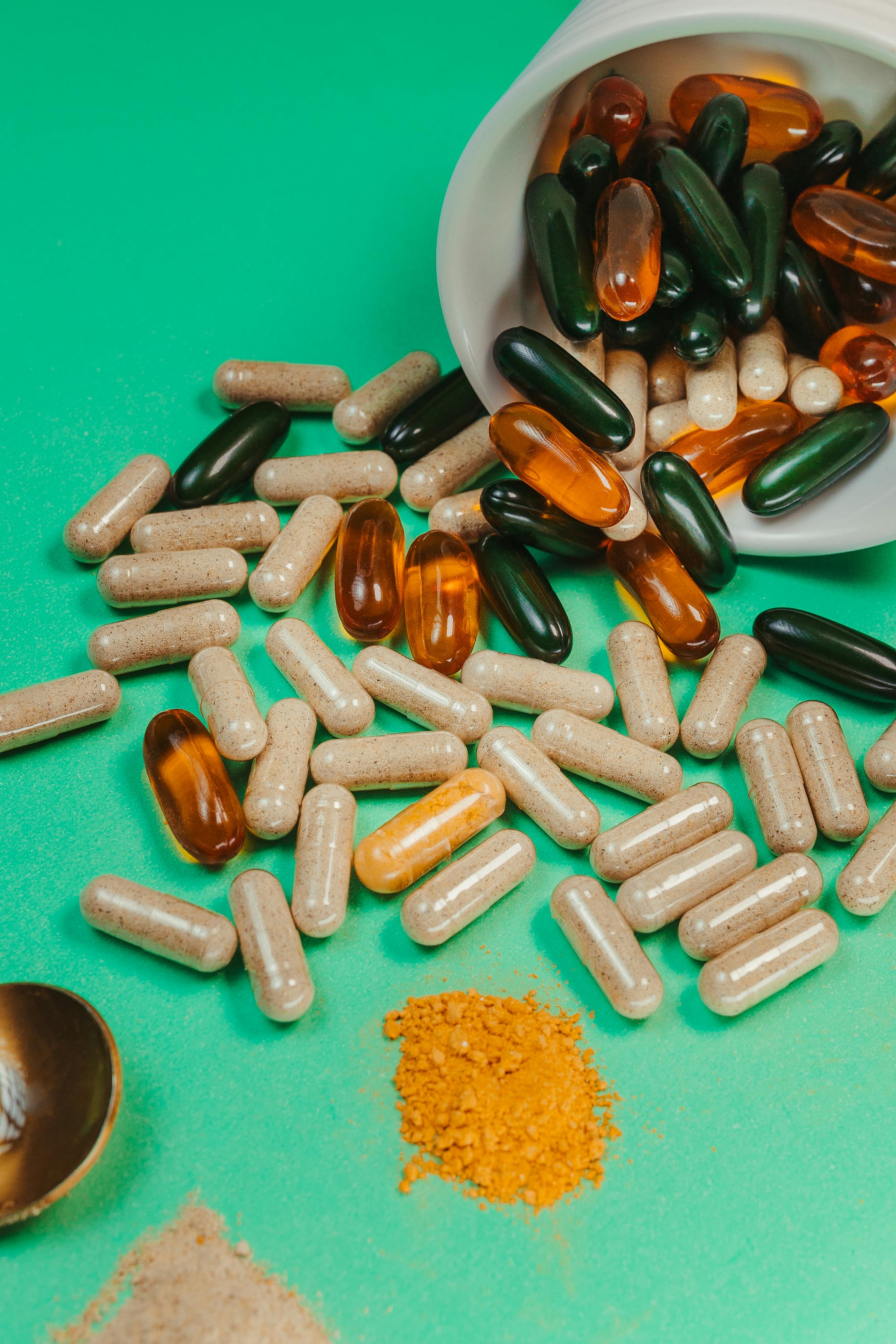 Multi Colored Capsules Dumping Out of Bowl · Free Stock Photo