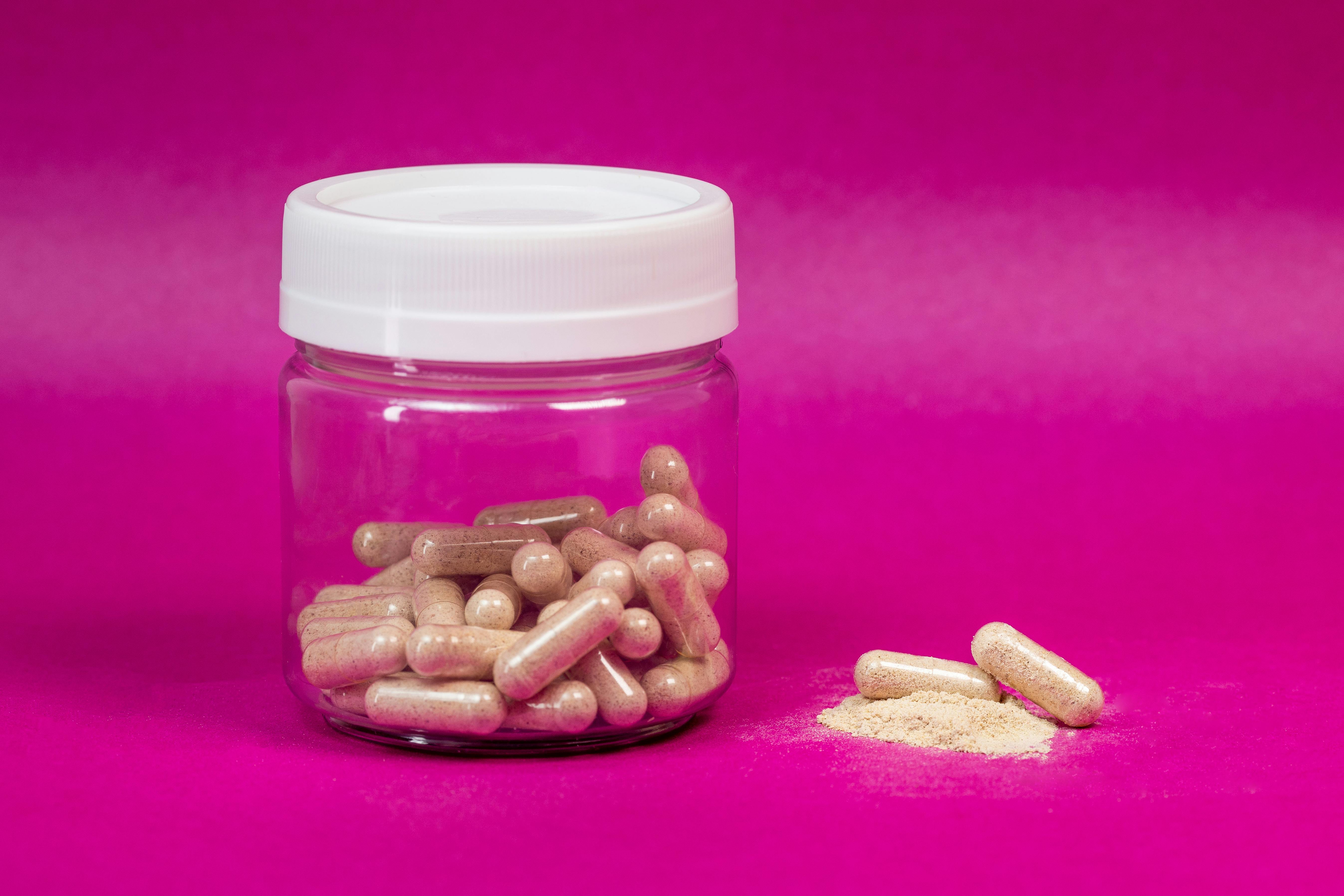 Medication Pills Isolated on Purple Background · Free Stock Photo