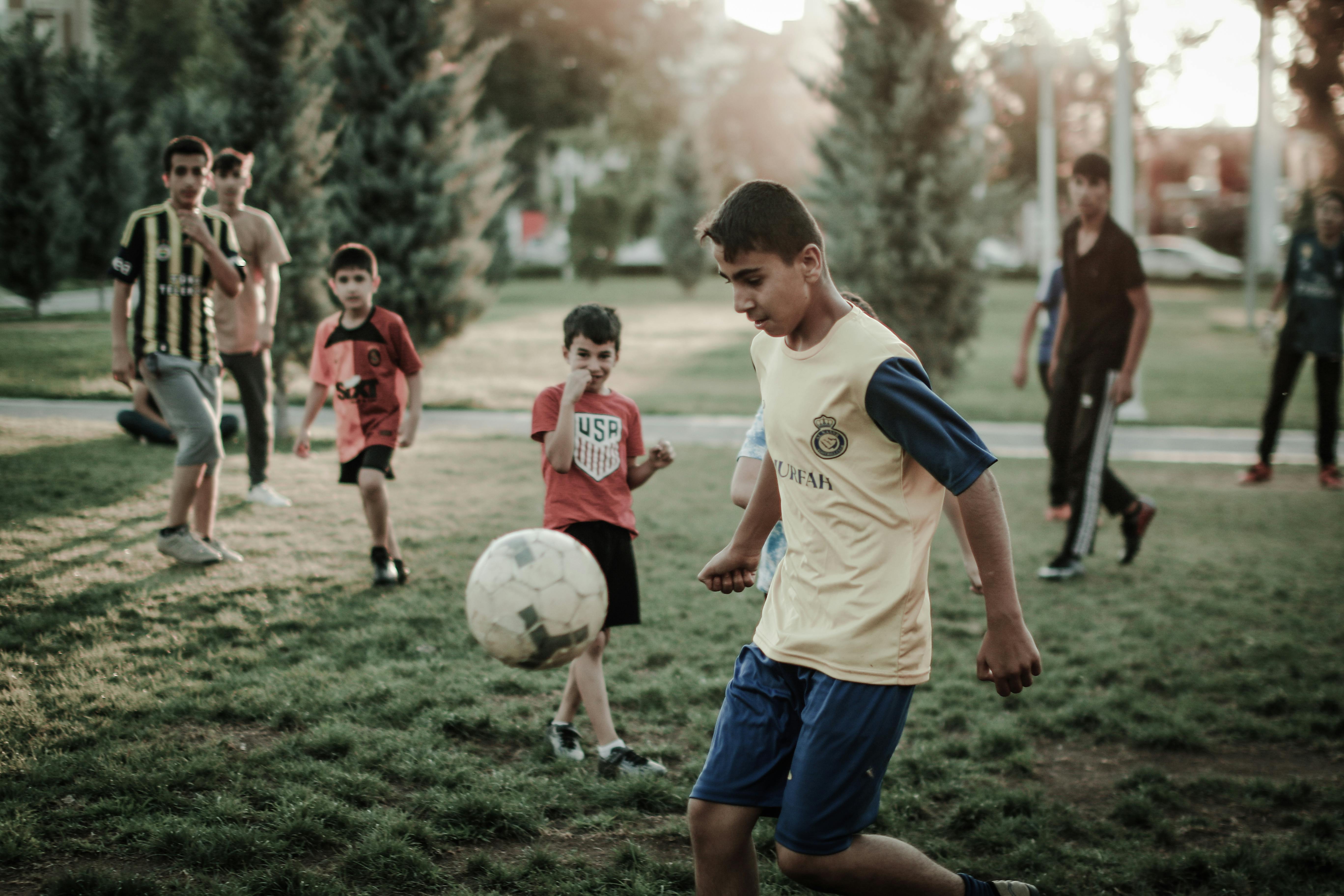 Boys Playing Football in Park · Free Stock Photo