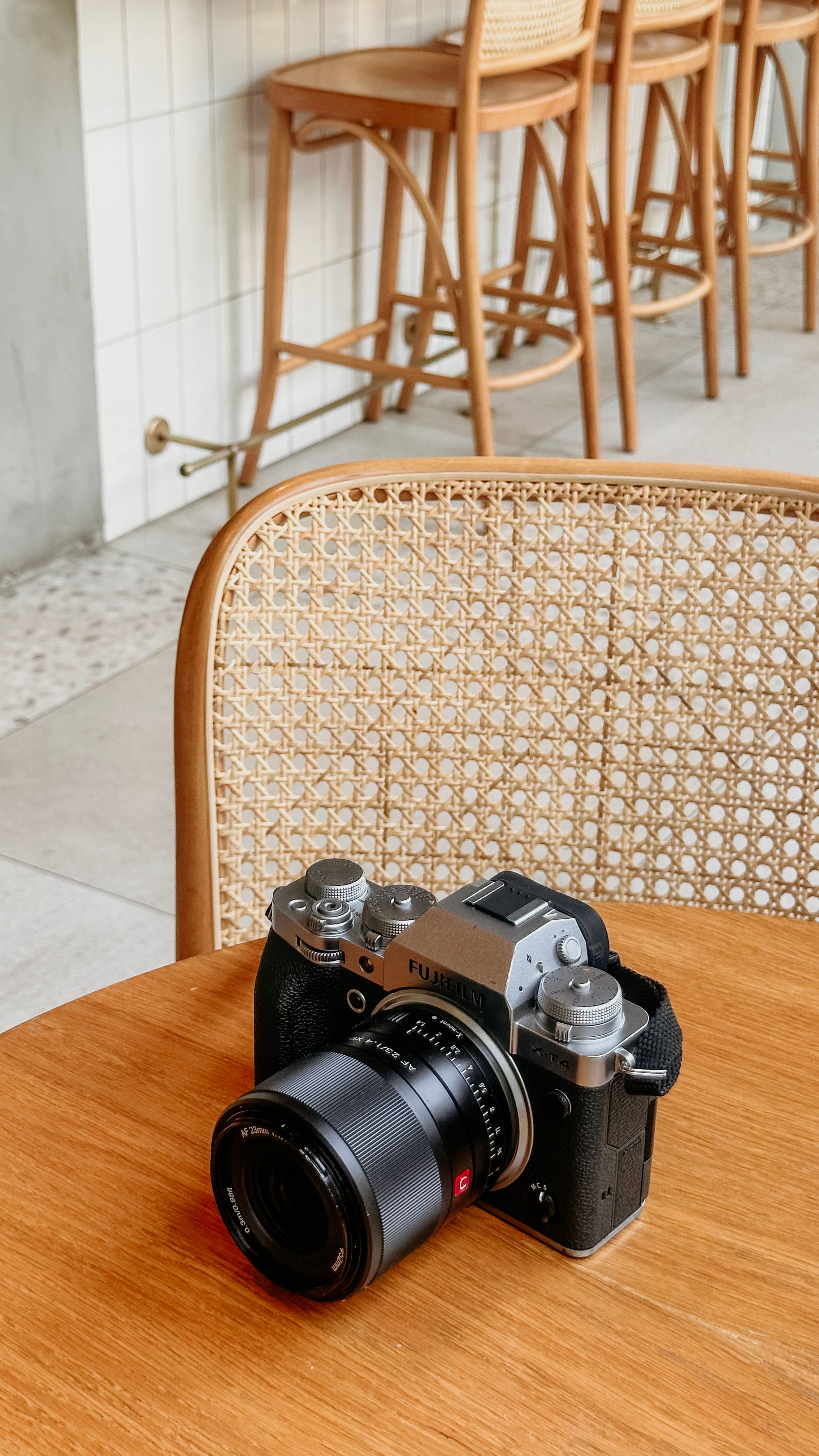 Fujifilm Analog Photo Camera Lying on a Cafe Table · Free Stock Photo