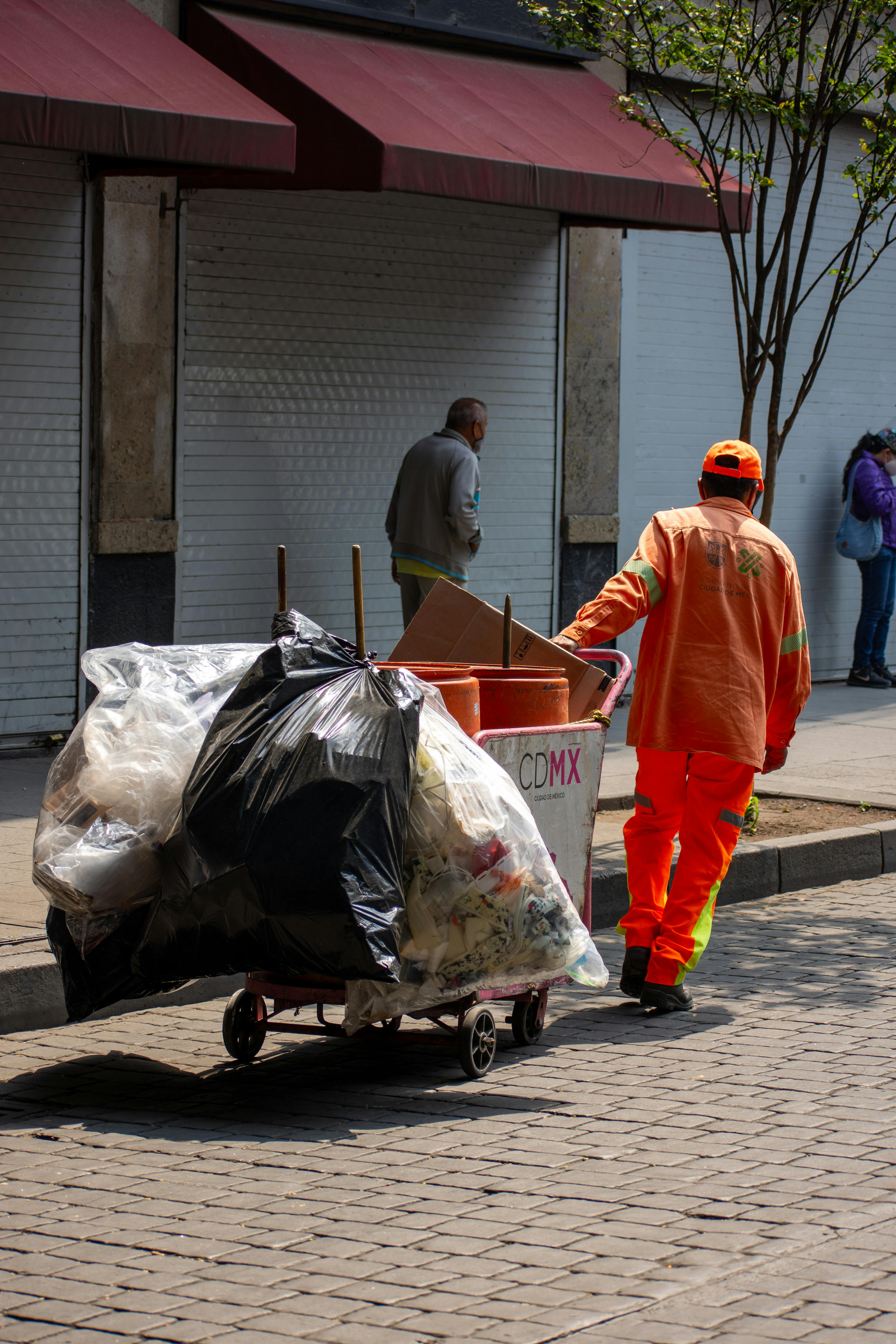 Street Sweeper Pulling Cart with Garbage · Free Stock Photo