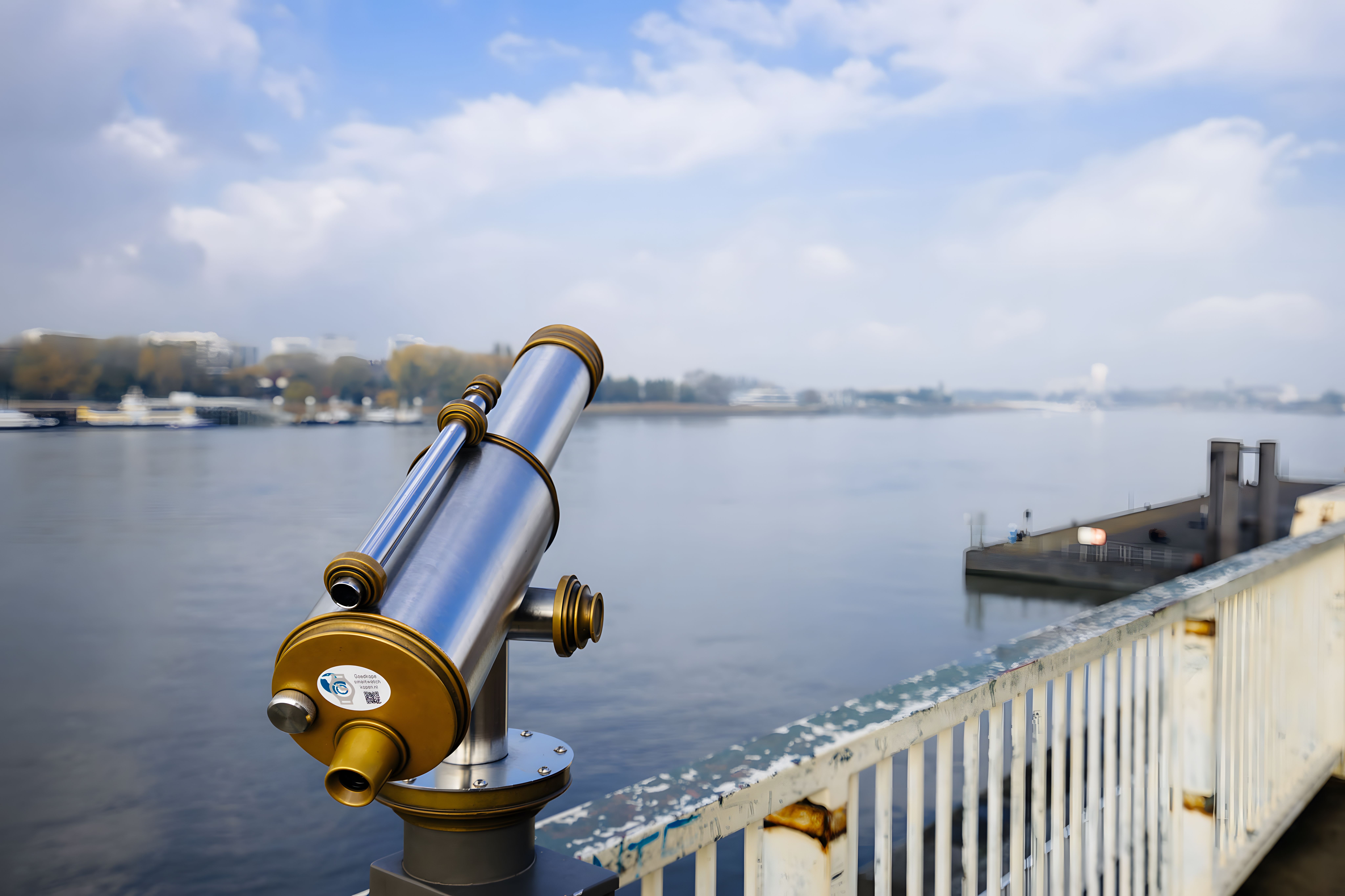 A telescope on a pier overlooking a body of water · Free Stock Photo