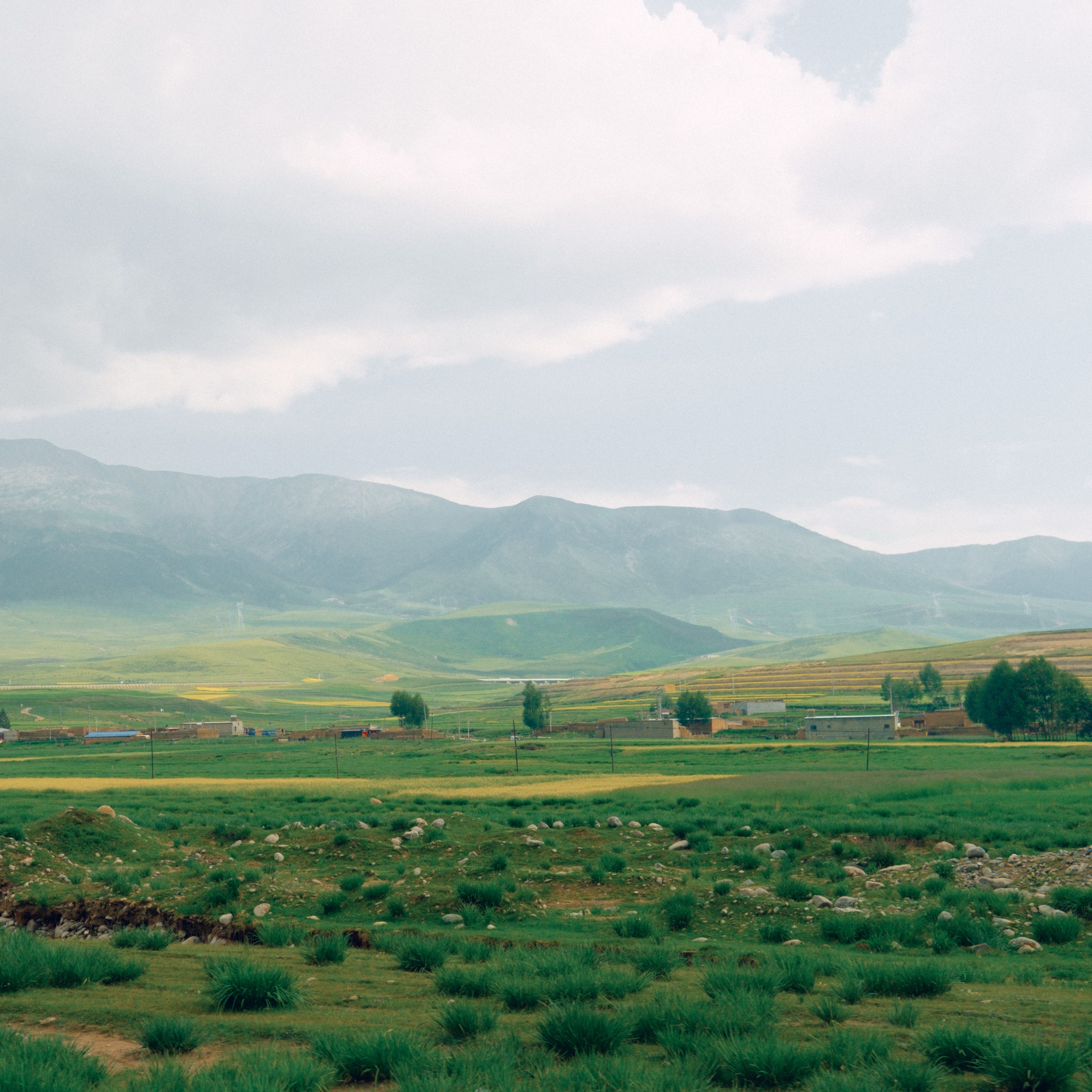 Rural Landscape with Mountain Range in the Background · Free Stock Photo