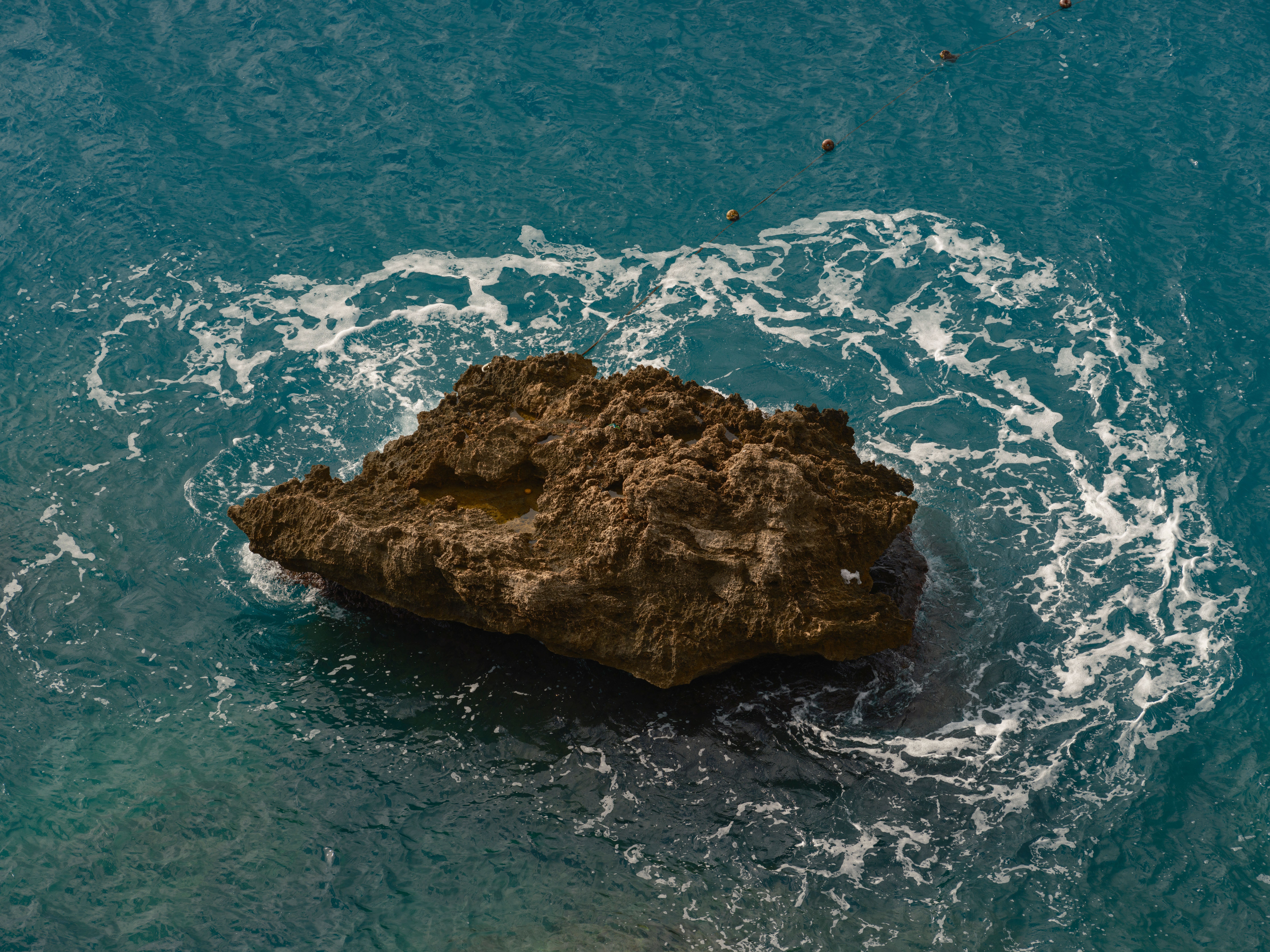 Top View of a Rock Formation in a Sea · Free Stock Photo