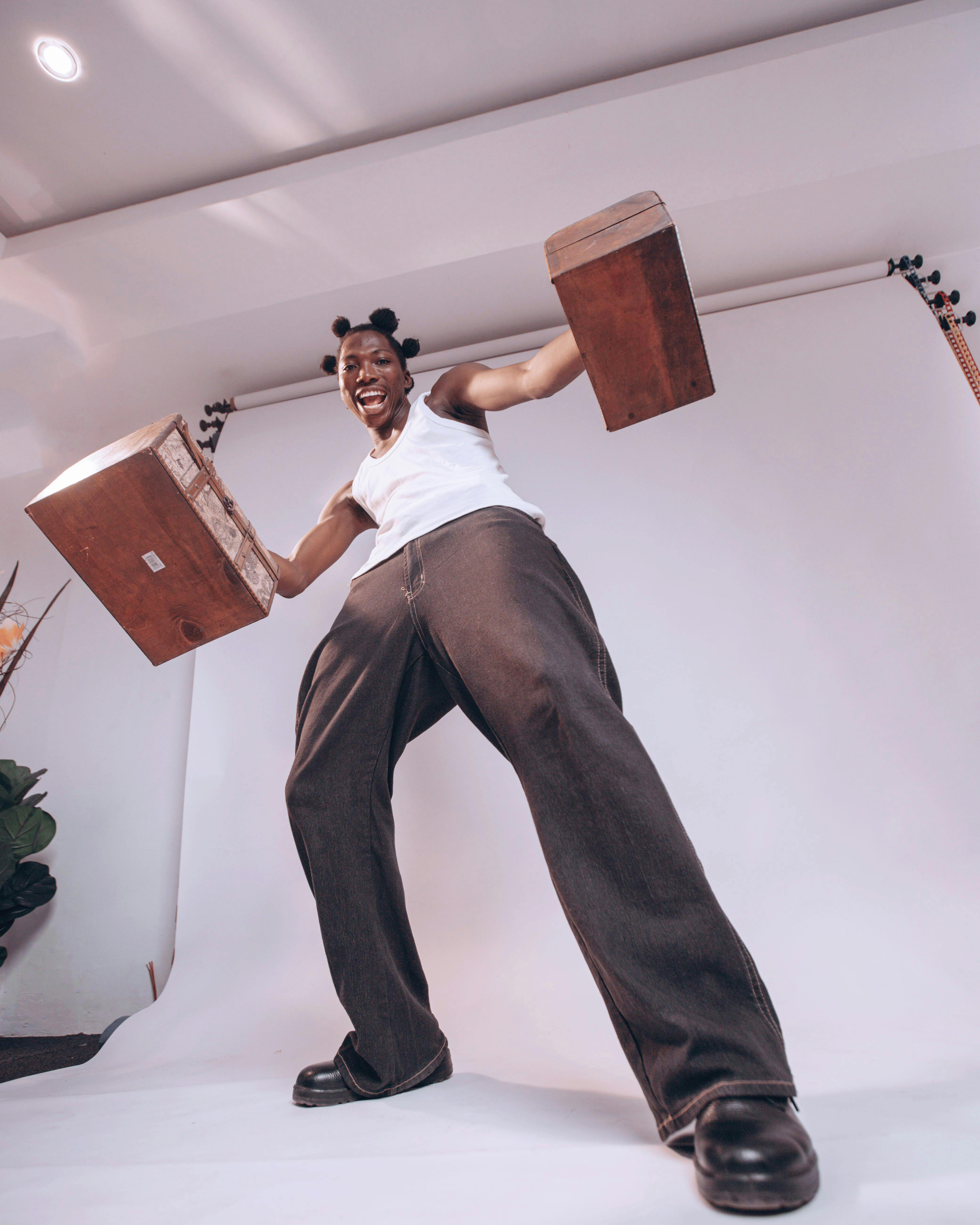 Man Holding Bricks in a Studio · Free Stock Photo
