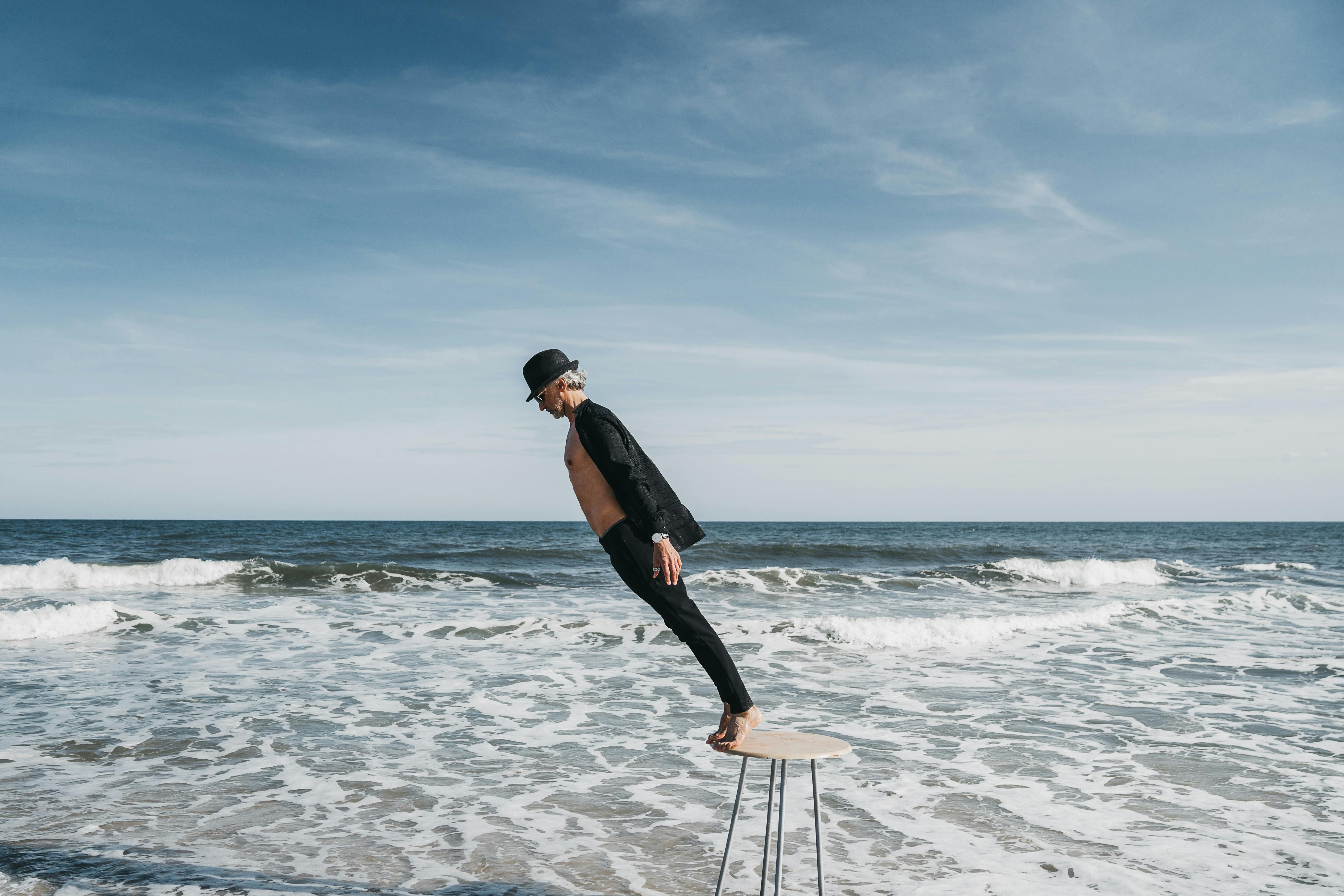 Man Standing on Stool at Seaside · Free Stock Photo