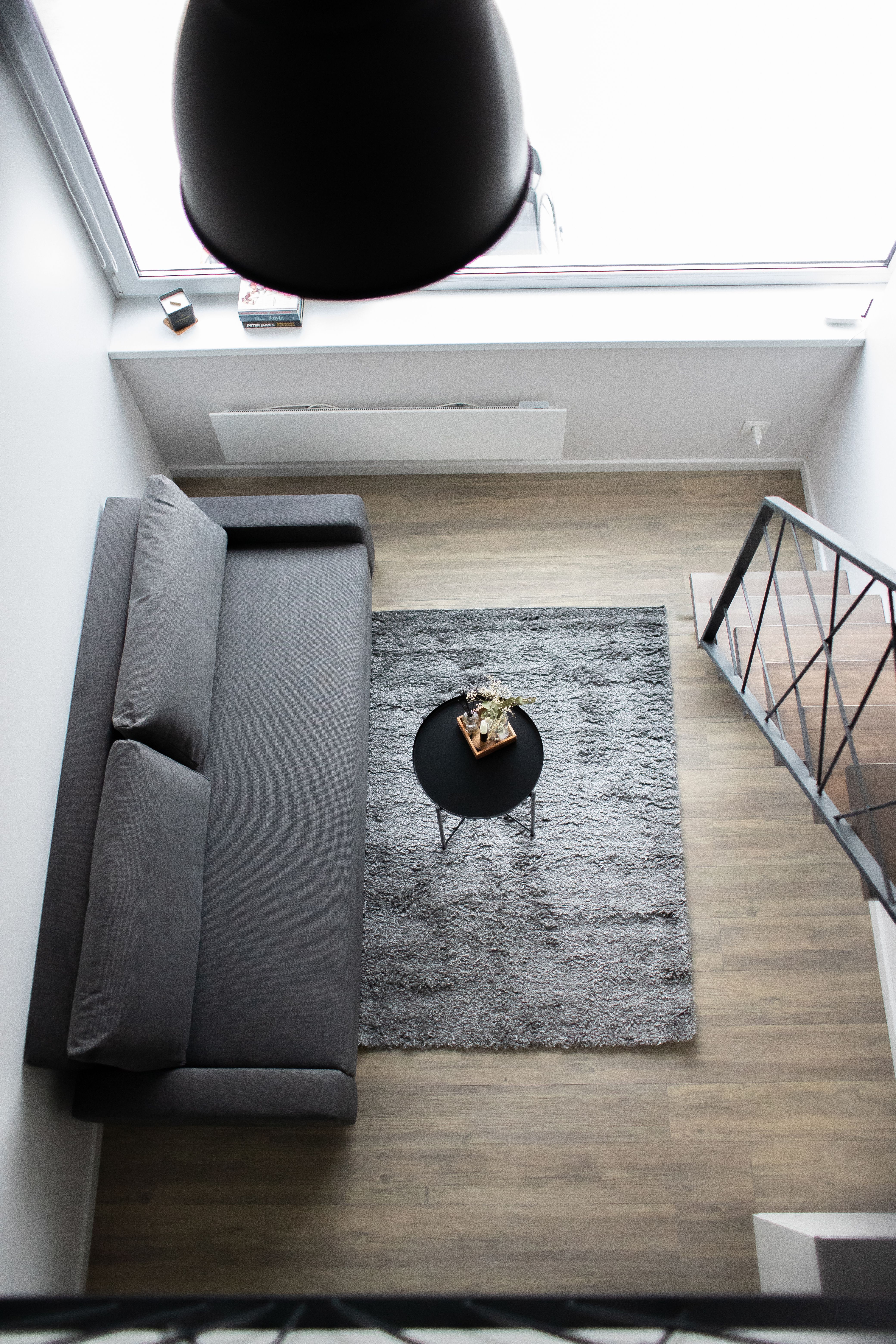 A Soft, Light Colored Sofa and a Wooden Chair in a Modern Living Room ...