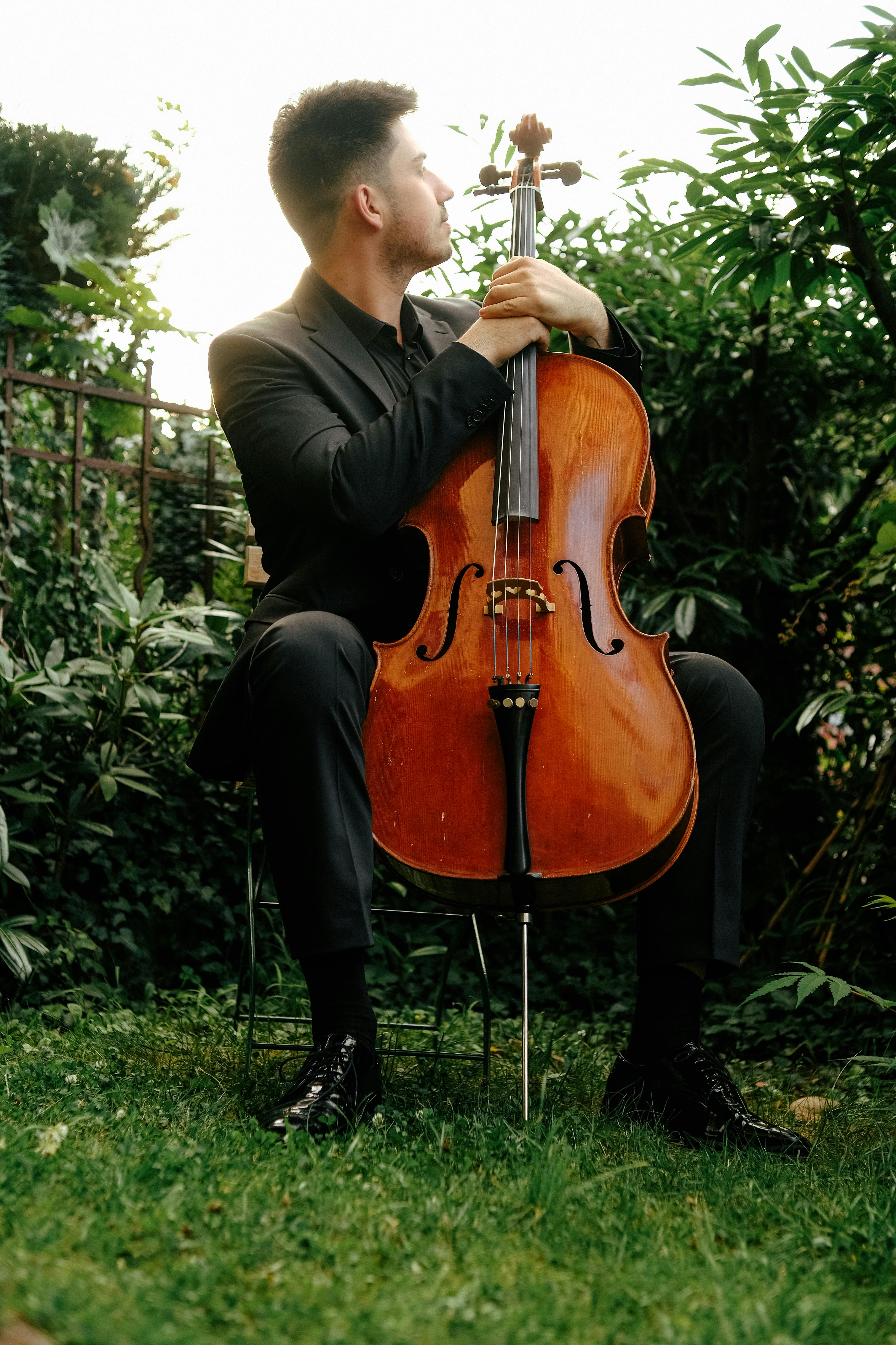 Sitting Man Holding Cello · Free Stock Photo