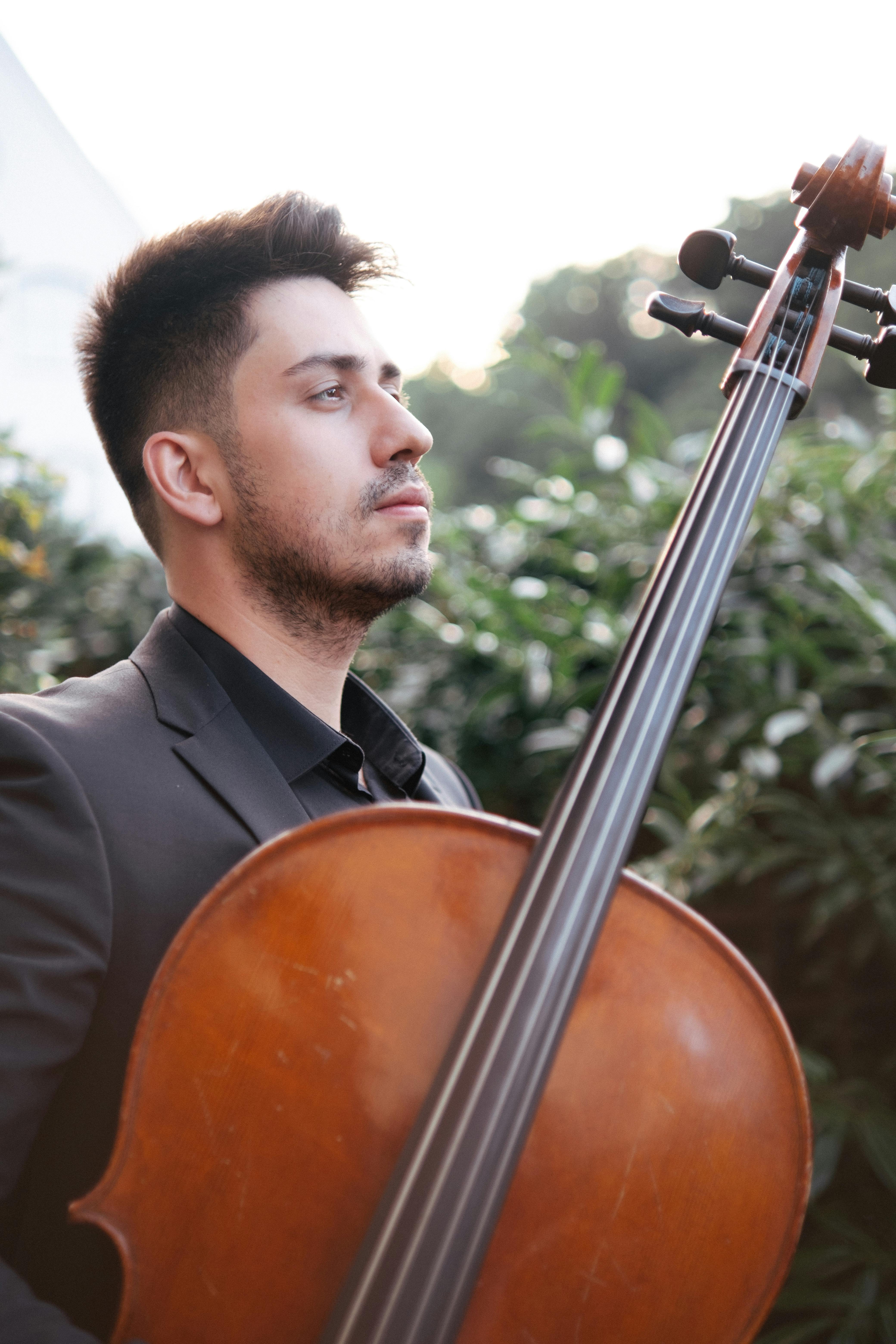 Man Holding Cello · Free Stock Photo