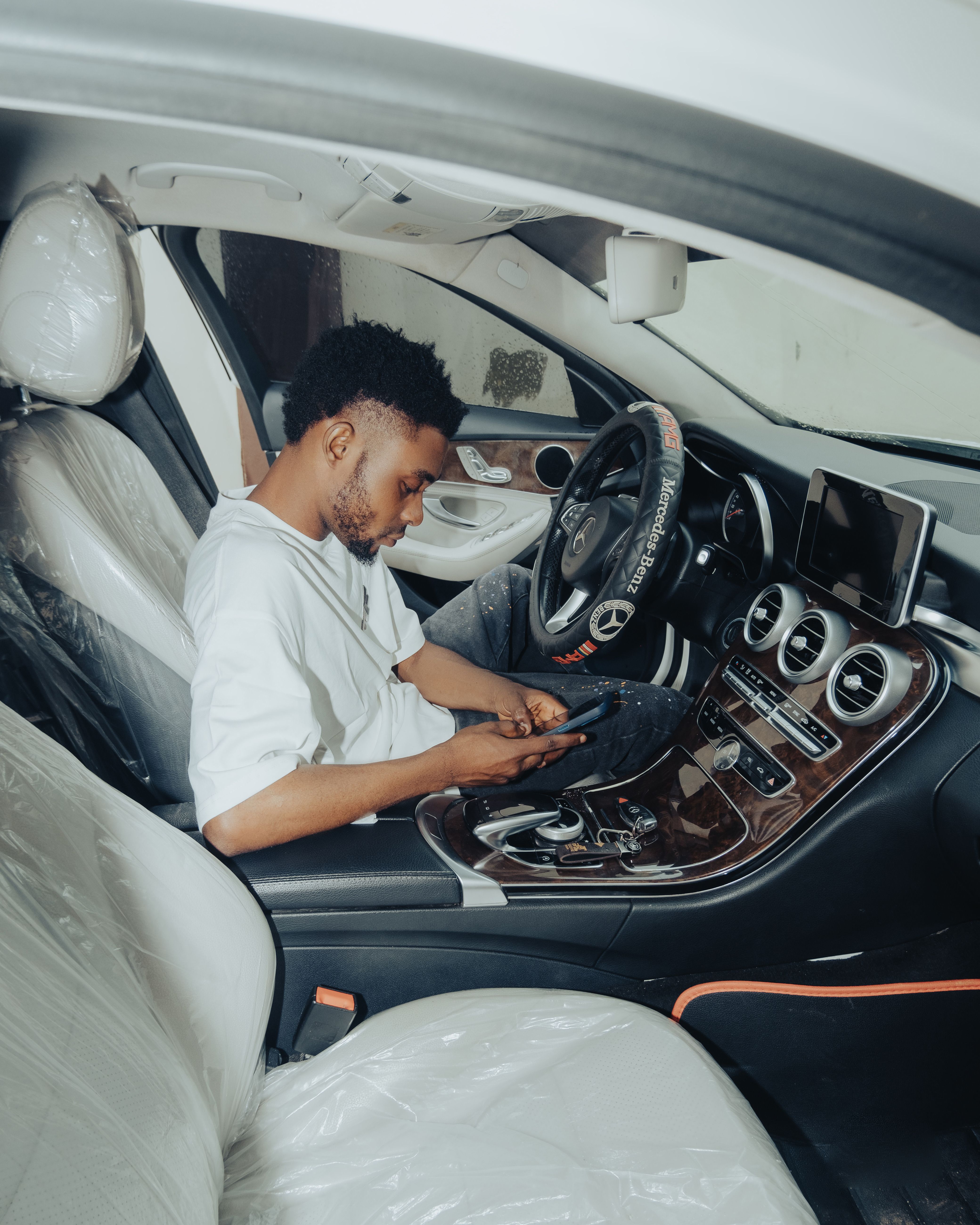 Young Man in a Bandana Sitting in an Old Mercedes · Free Stock Photo