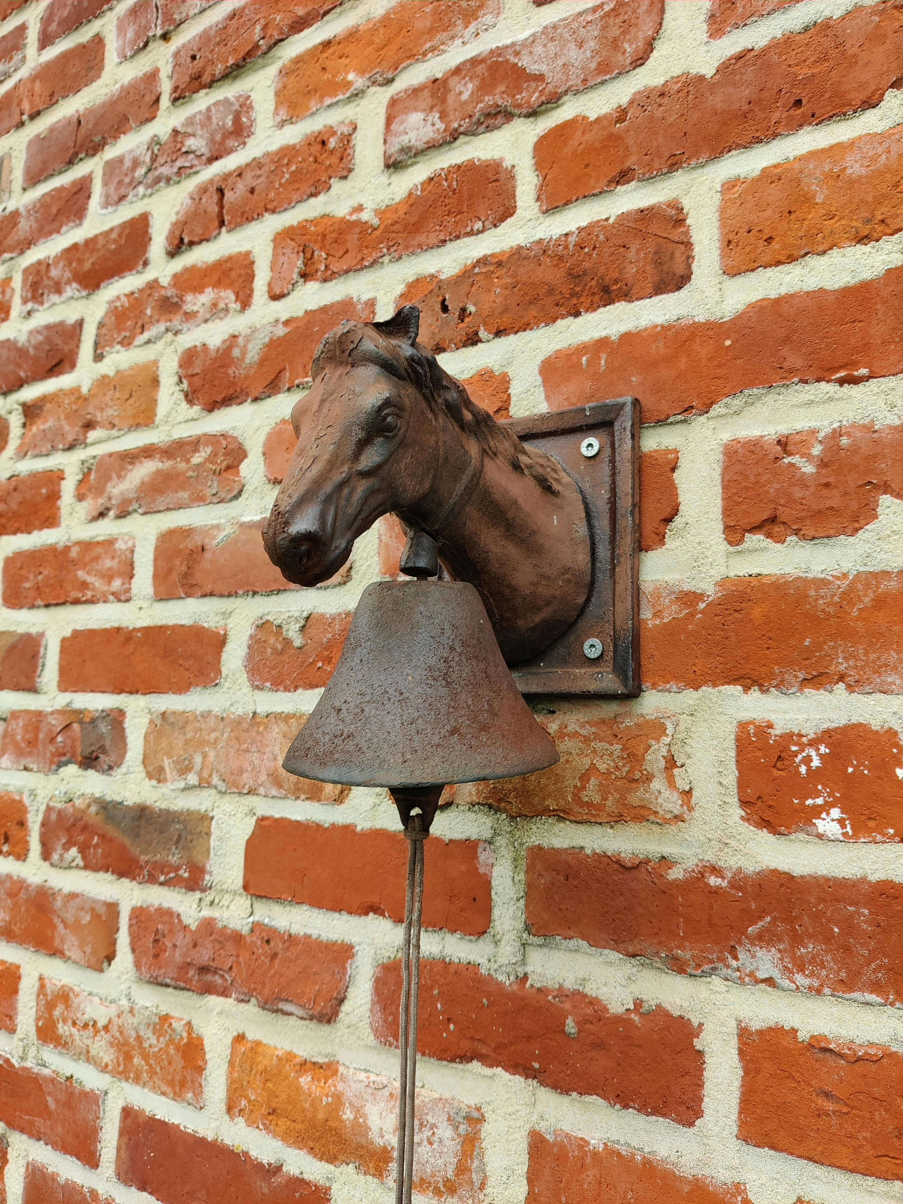 Horse Head Bell on a Brick Wall · Free Stock Photo