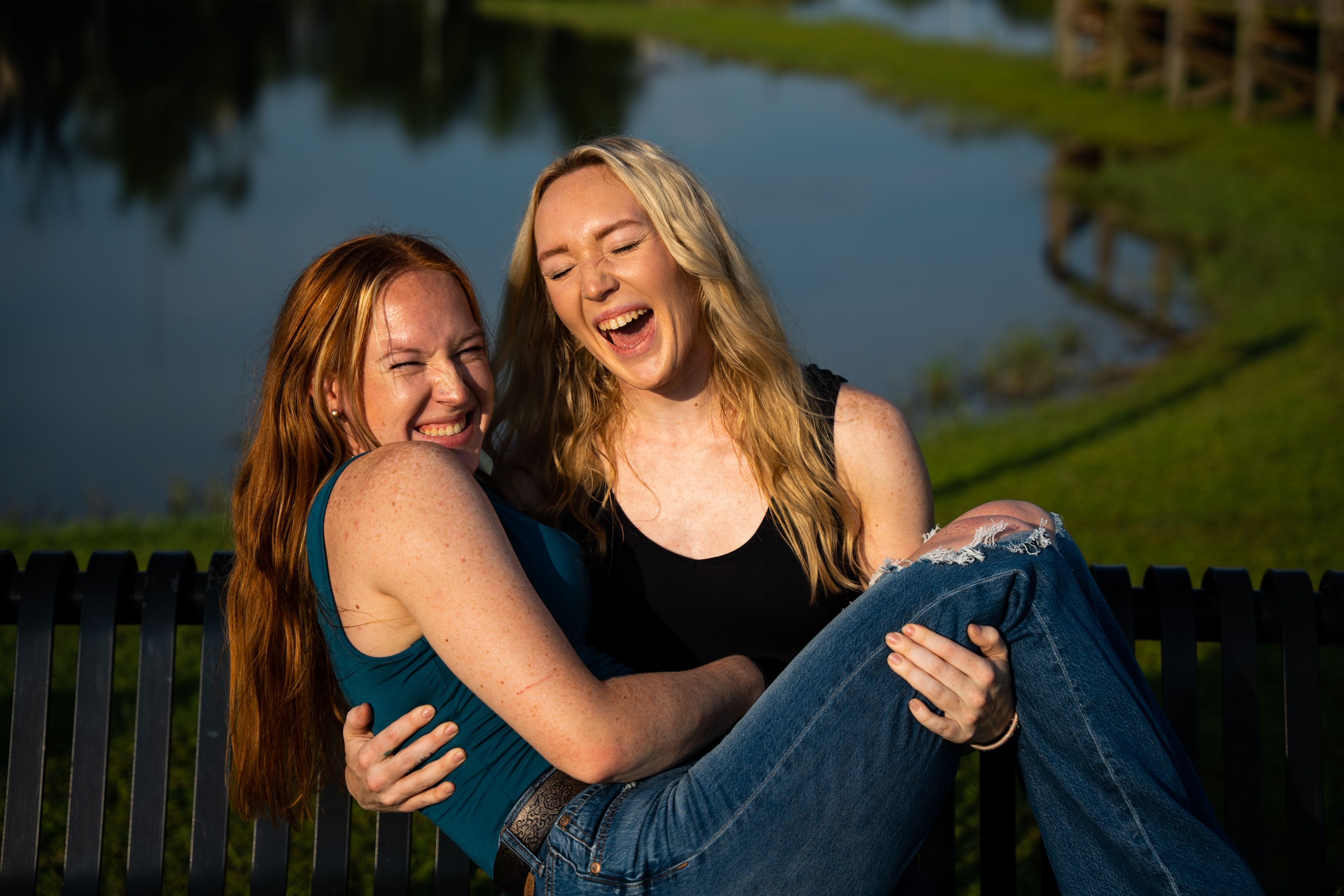 Two Young Women Sitting Outside and Laughing · Free Stock Photo