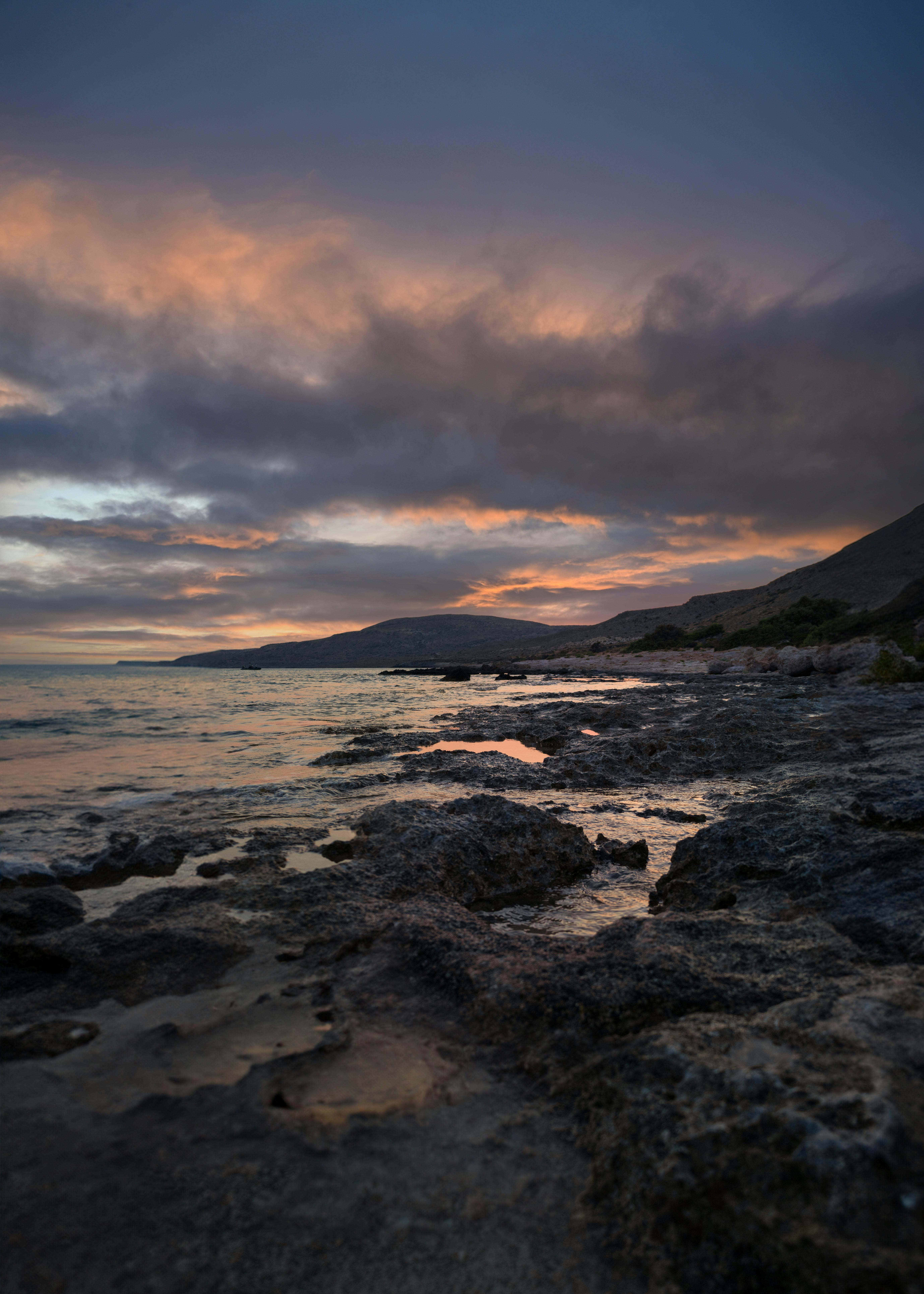 Rocky Seashore on Cloudy Evening · Free Stock Photo