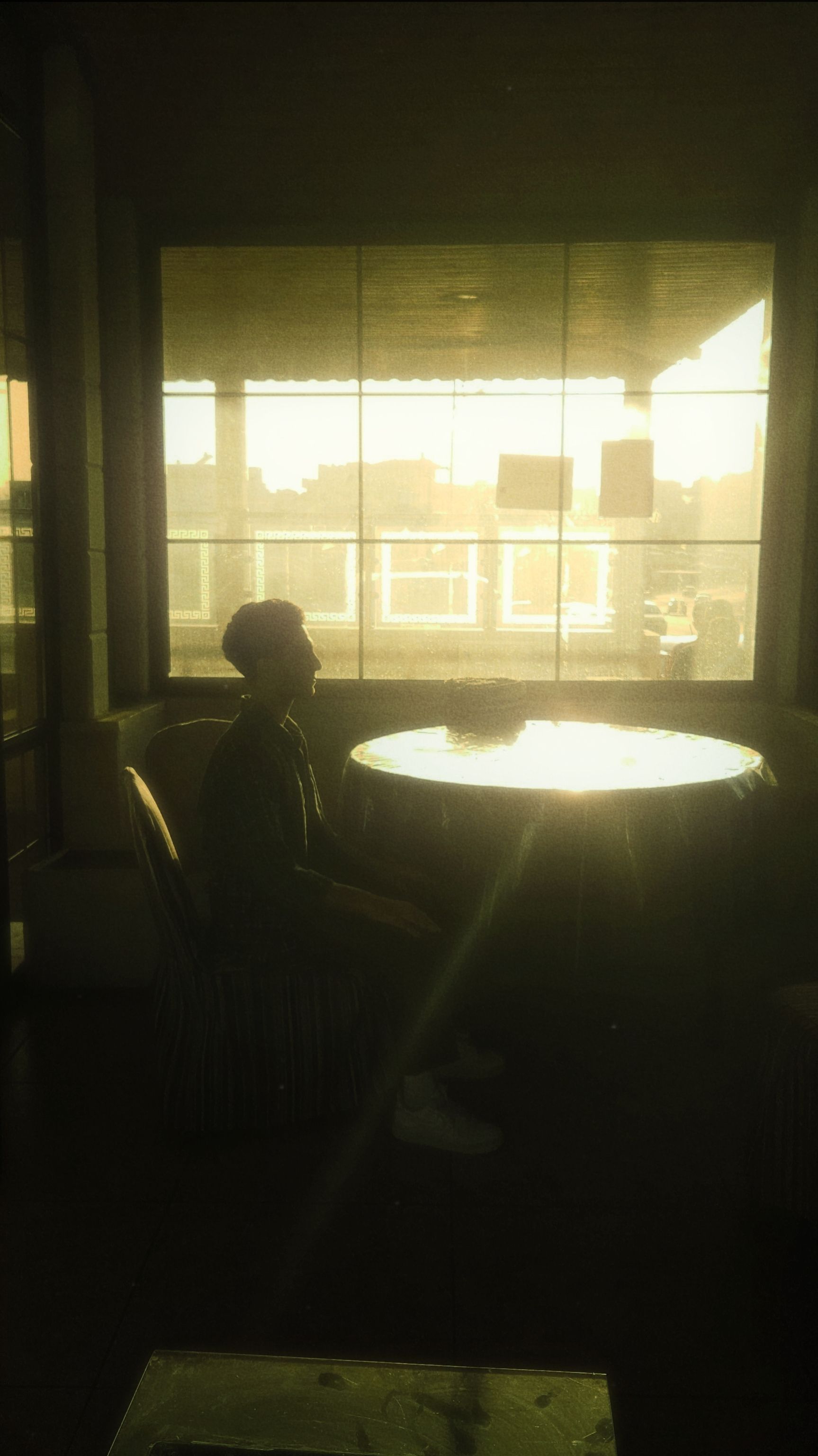 Man Sitting at a Round Table Reflecting Sunlight · Free Stock Photo