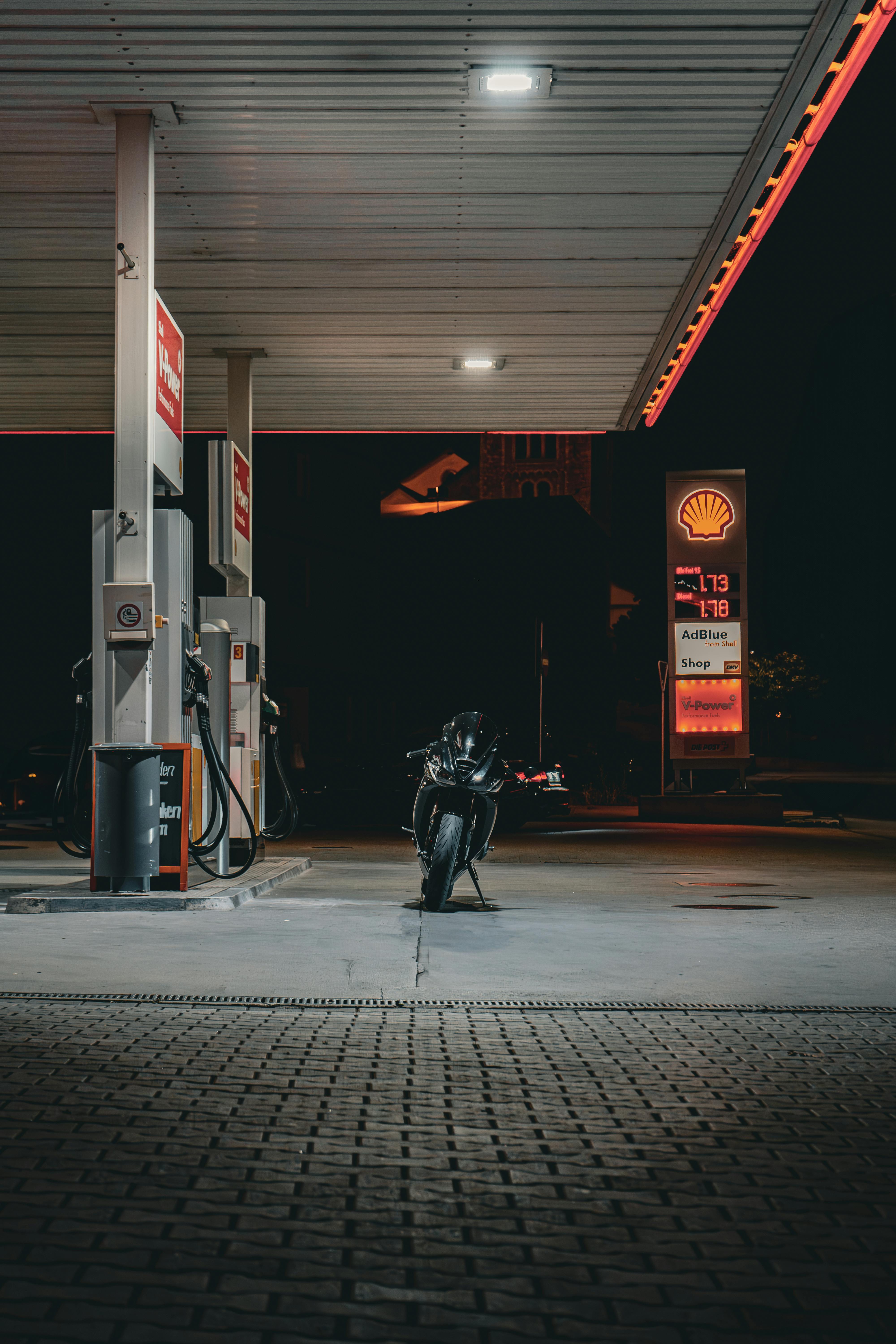 Shell Gas Station with Black Motorcycle · Free Stock Photo