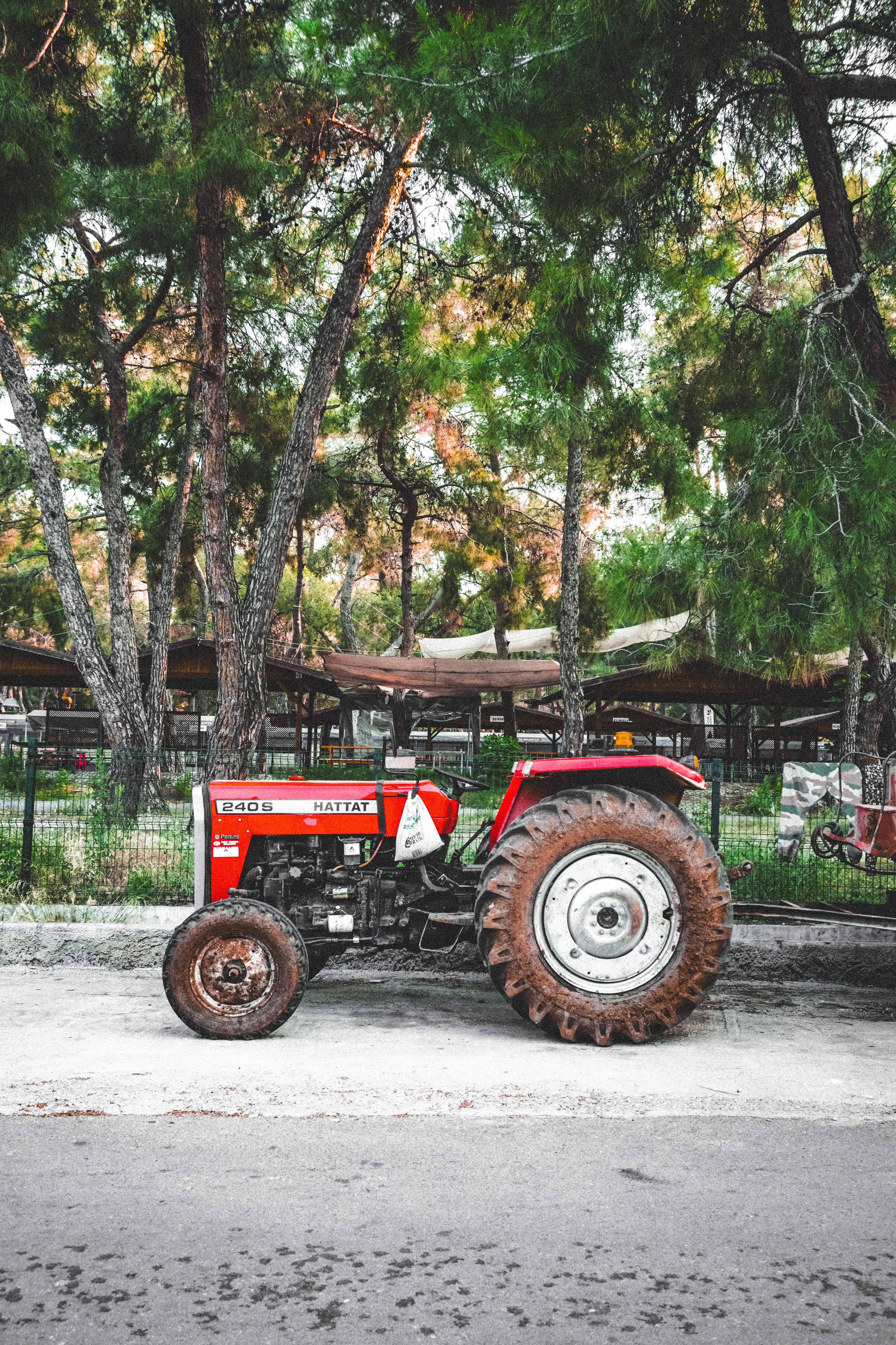 Photo of a Tractor Parked by a Park · Free Stock Photo