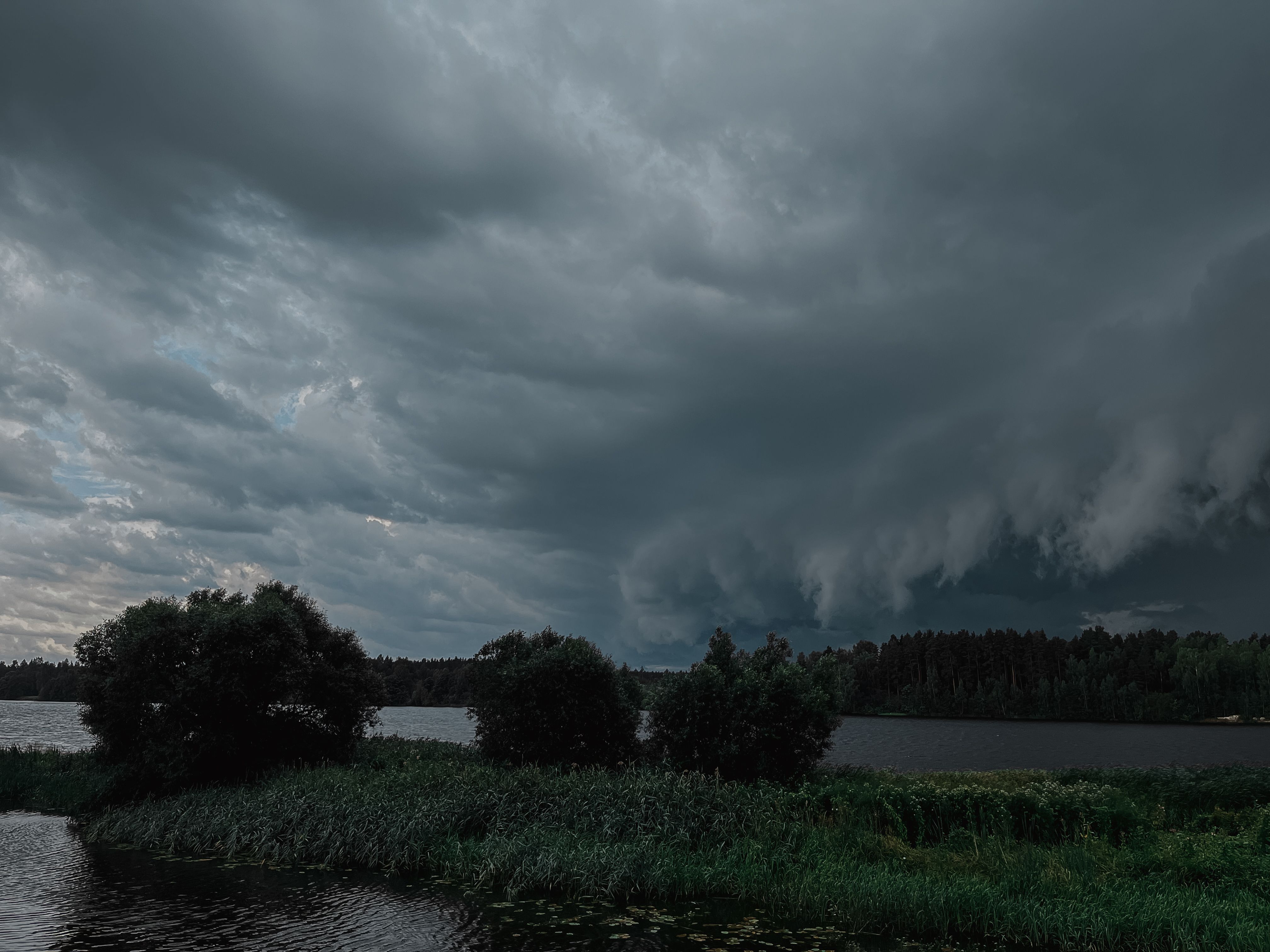 Dramatic Sky with Gray Storm Clouds over the Lake · Free Stock Photo