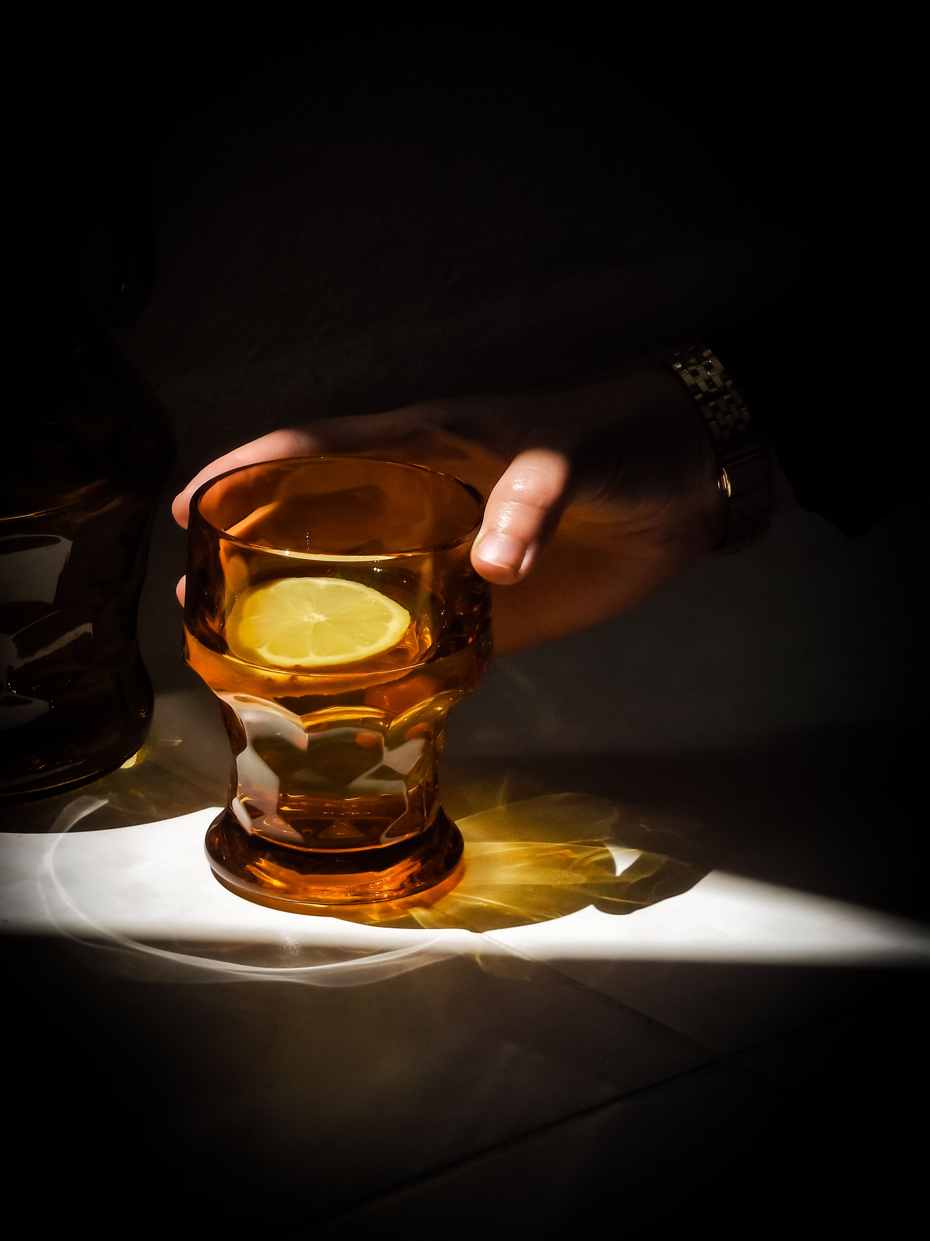 Hand Holding Glass in Darkness · Free Stock Photo