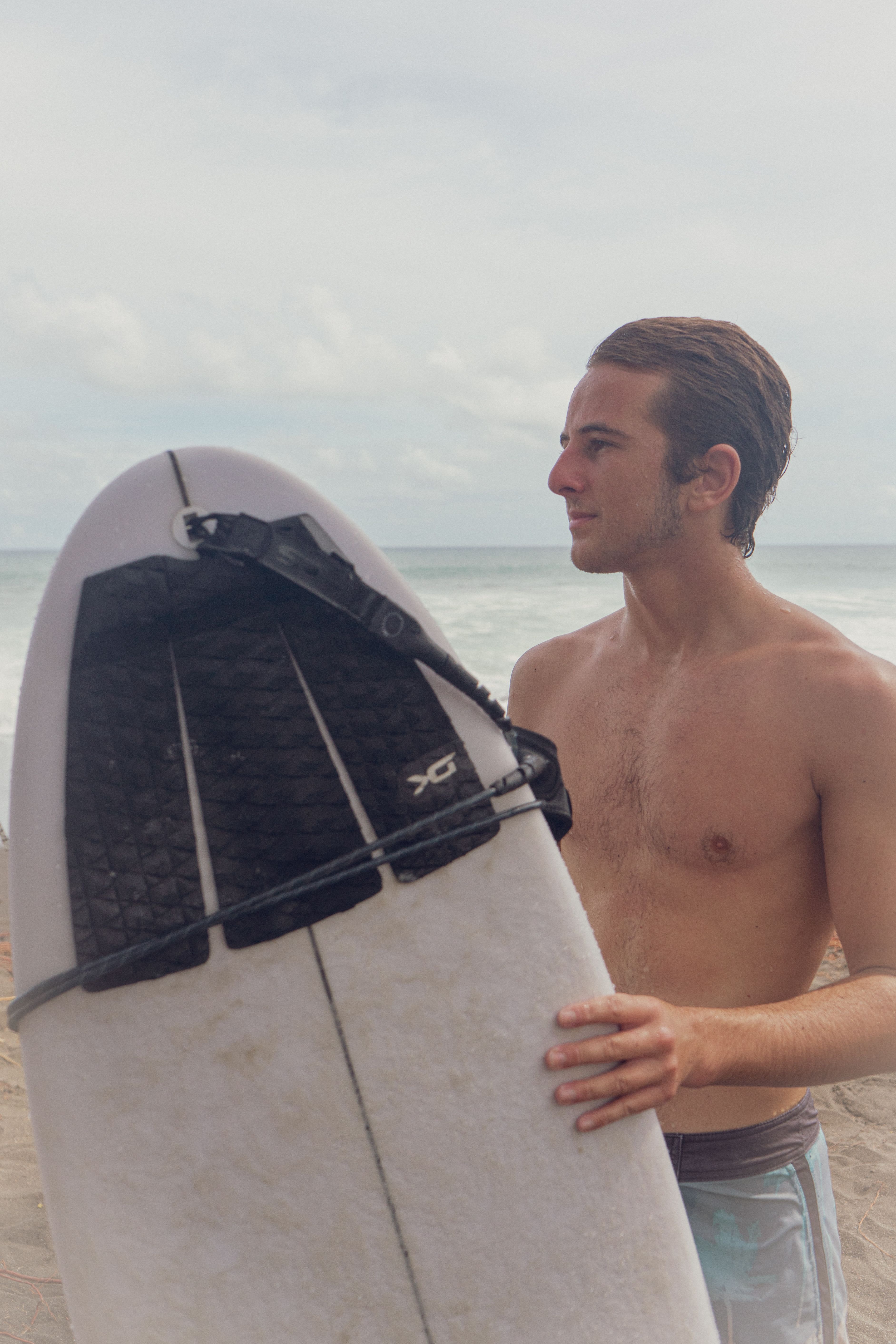Surfer with Surfboard on Sea Shore · Free Stock Photo