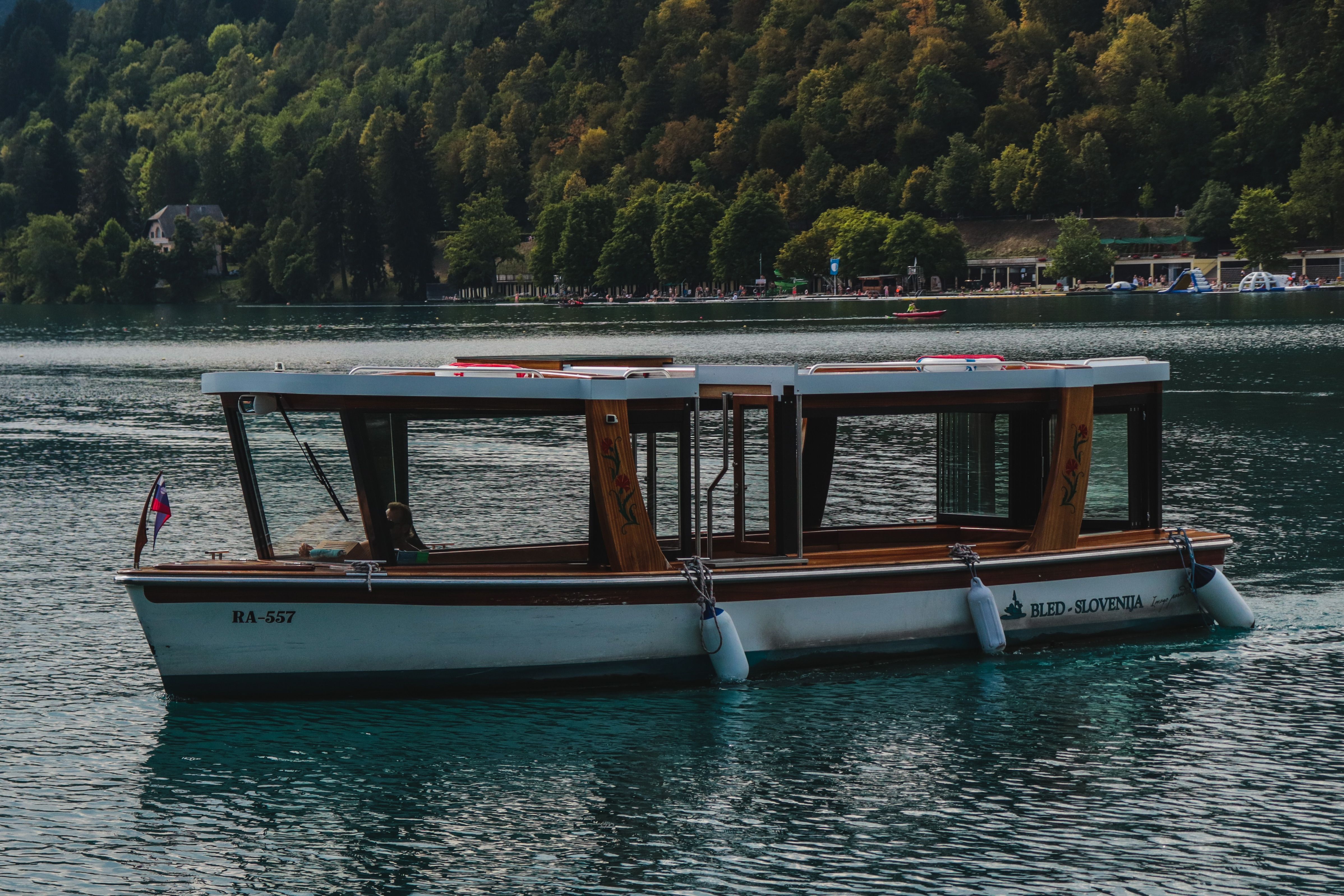 Boat Sailing in Water near Bank with Trees · Free Stock Photo