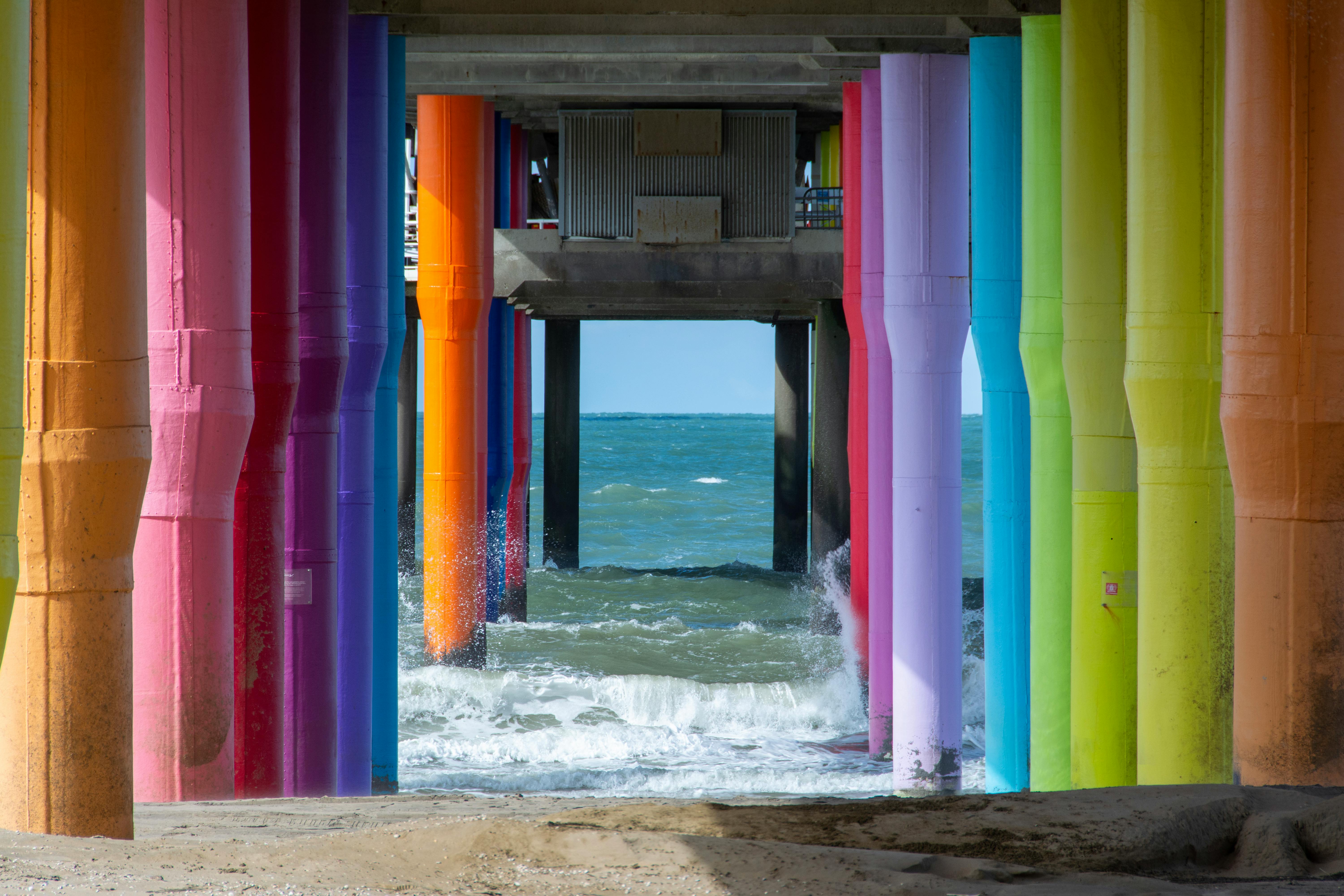 Colorful Poles by the Shore · Free Stock Photo