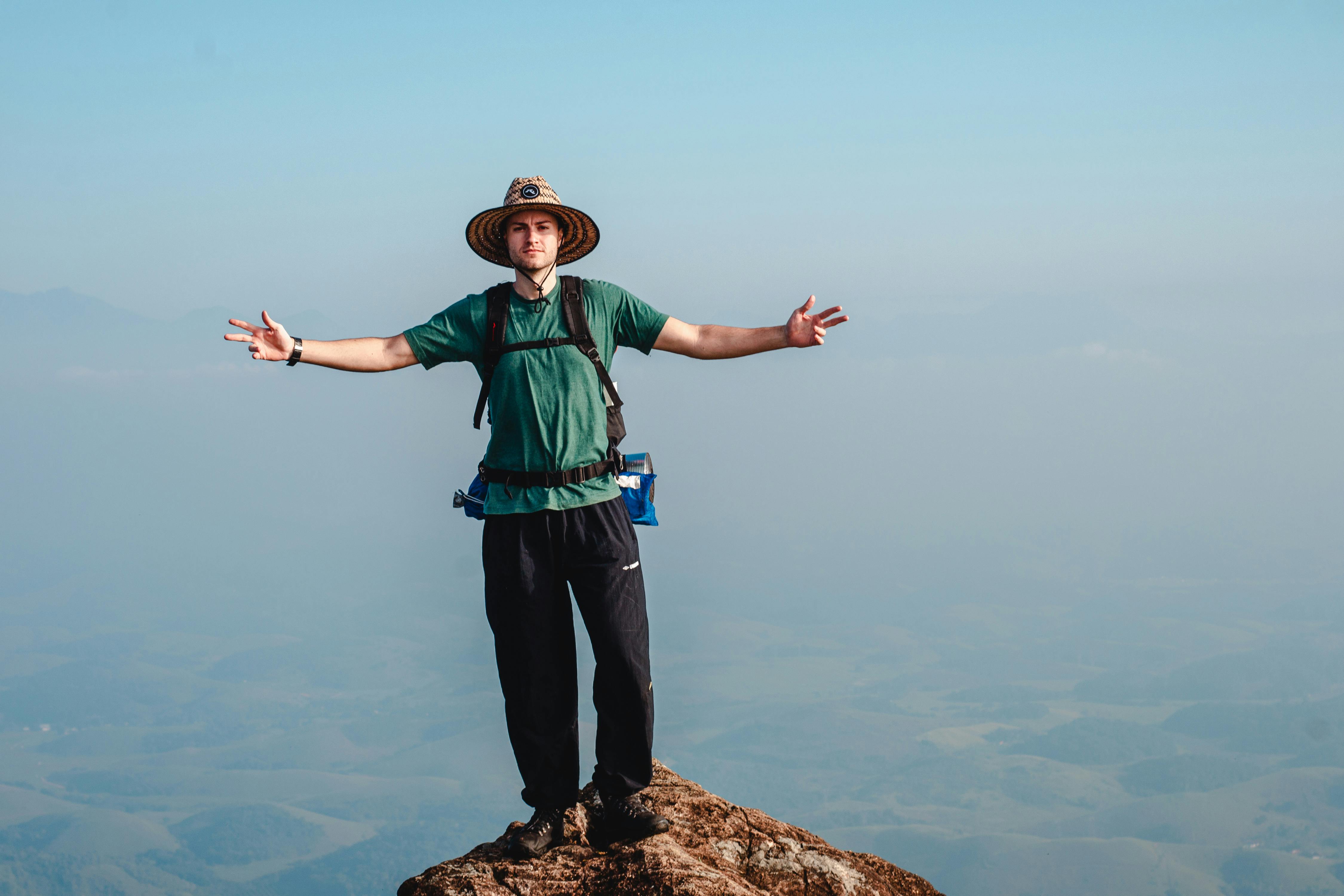 Man Posing on Rock Top Edge · Free Stock Photo