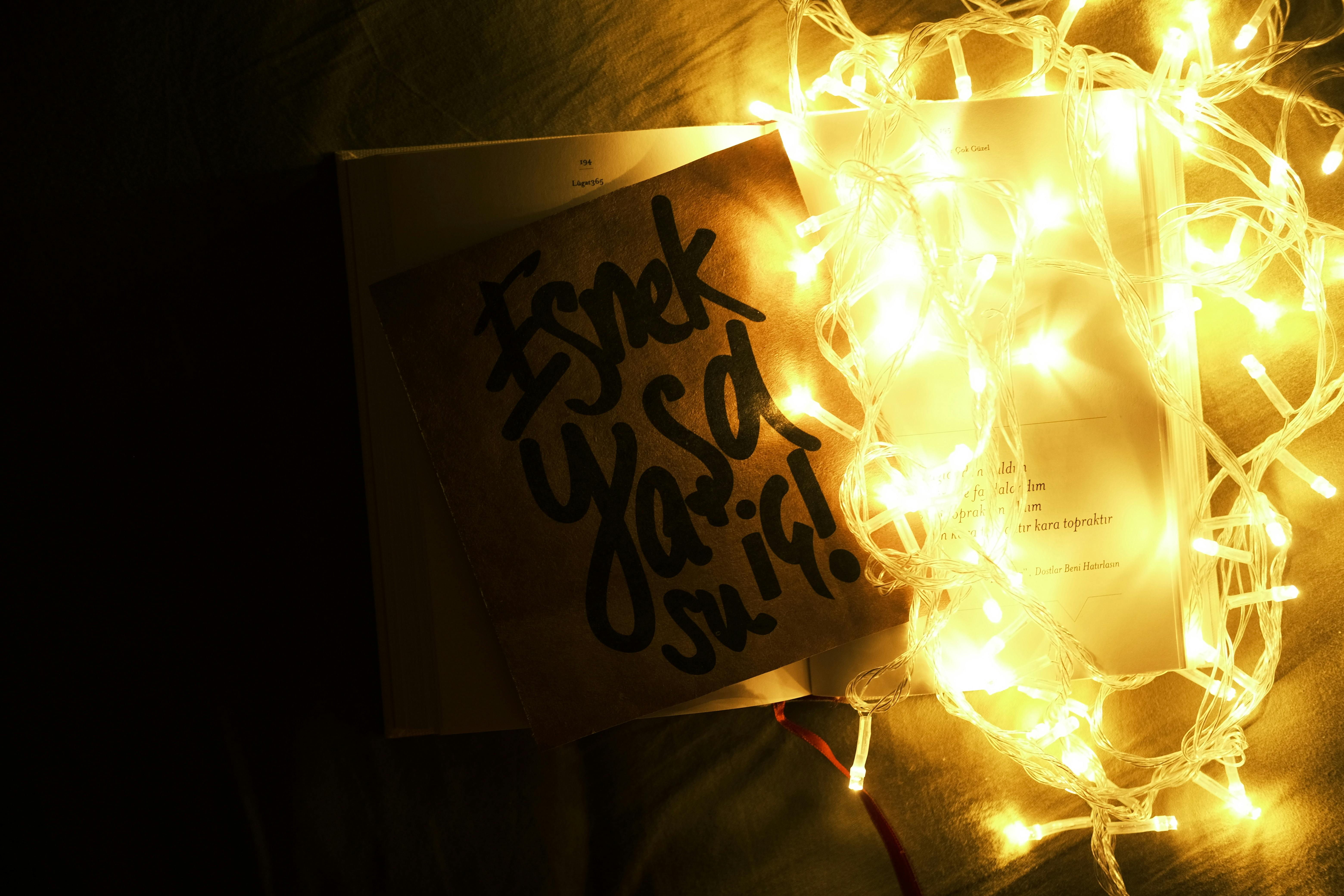 Open Book With String Lights · Free Stock Photo