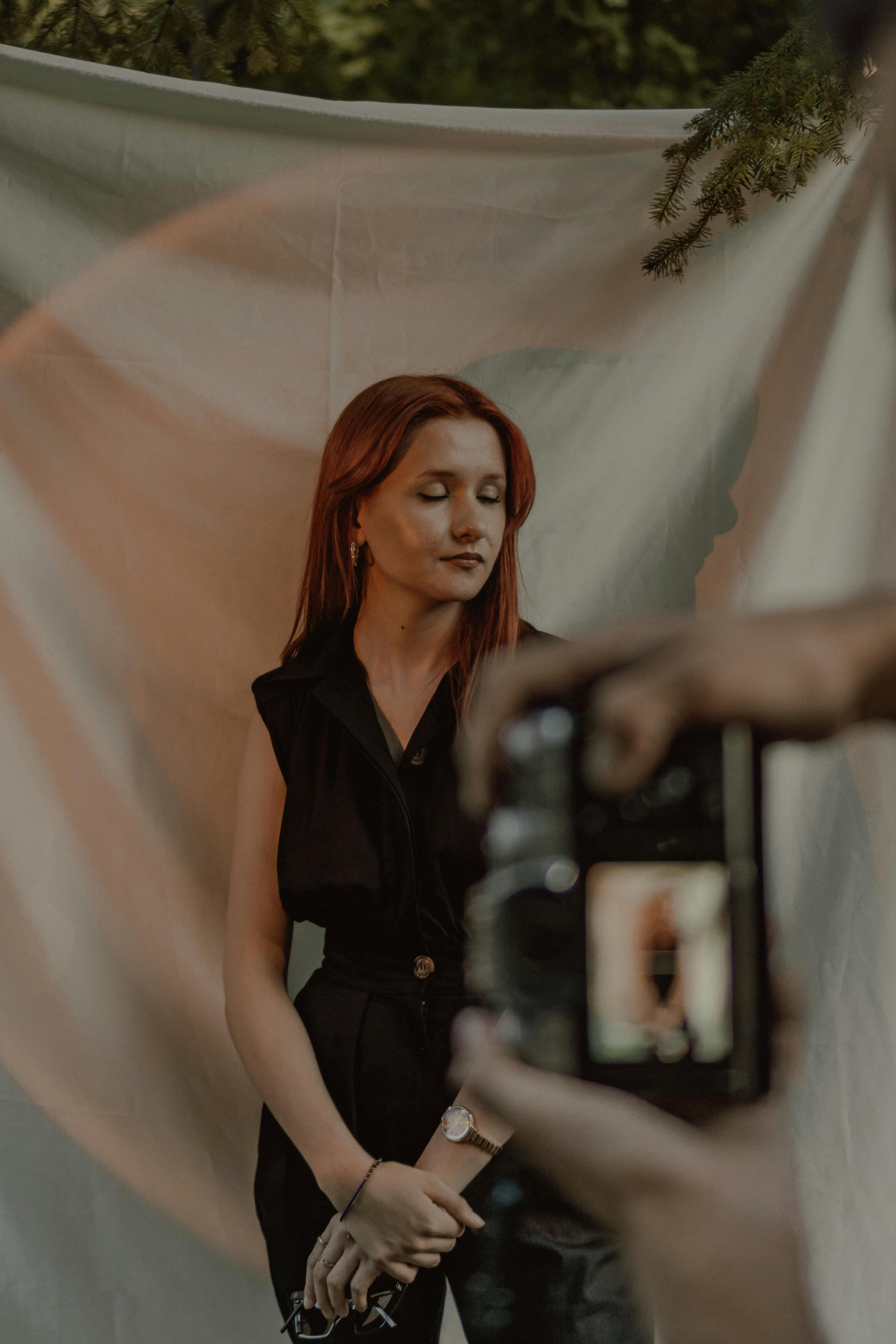 A Model Posing Outside on the Background of a White Sheet · Free Stock ...