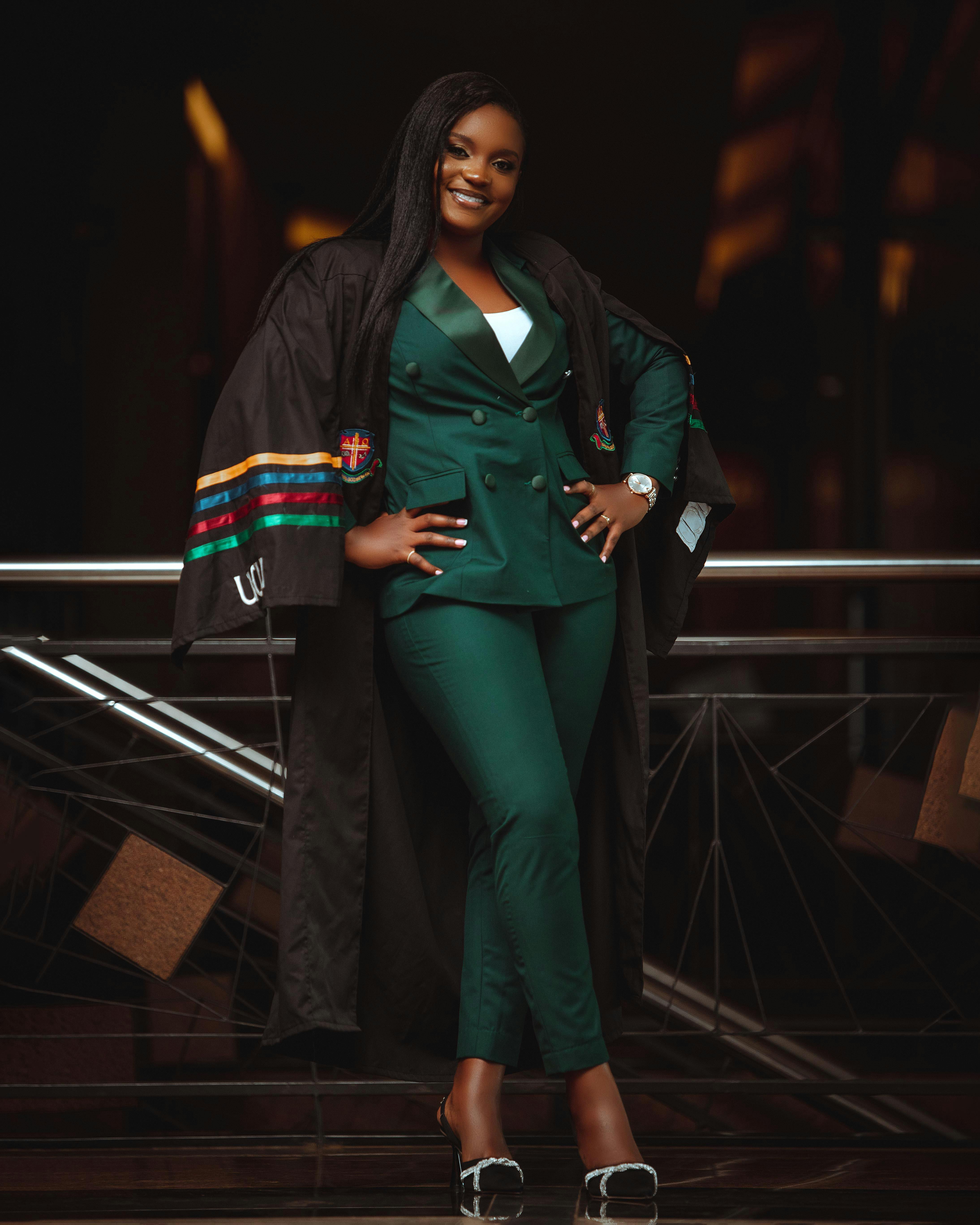 Smiling Graduate in Green Suit and in Gown · Free Stock Photo
