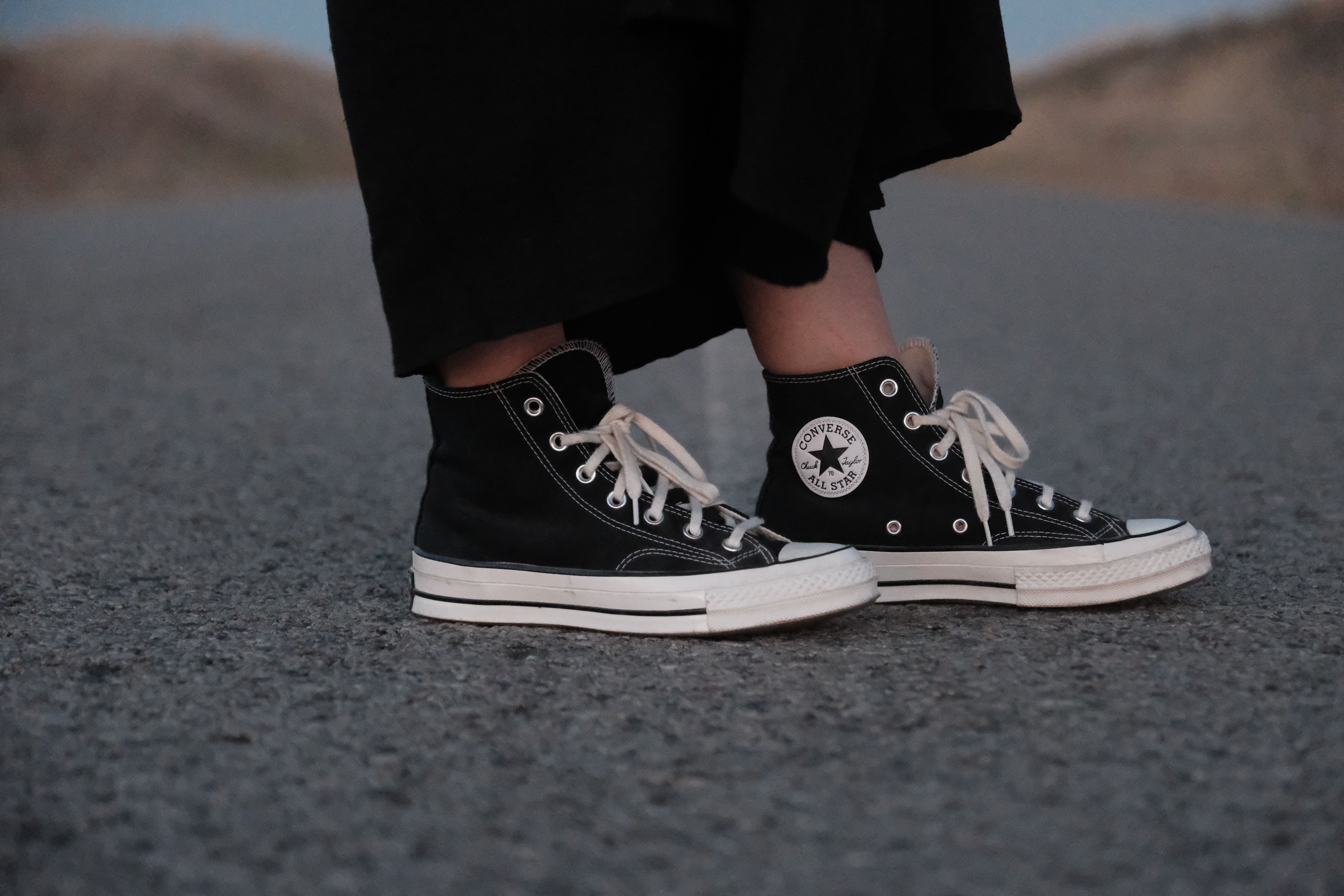 Close up of Woman in Converse Shoes on Asphalt Road · Free Stock Photo