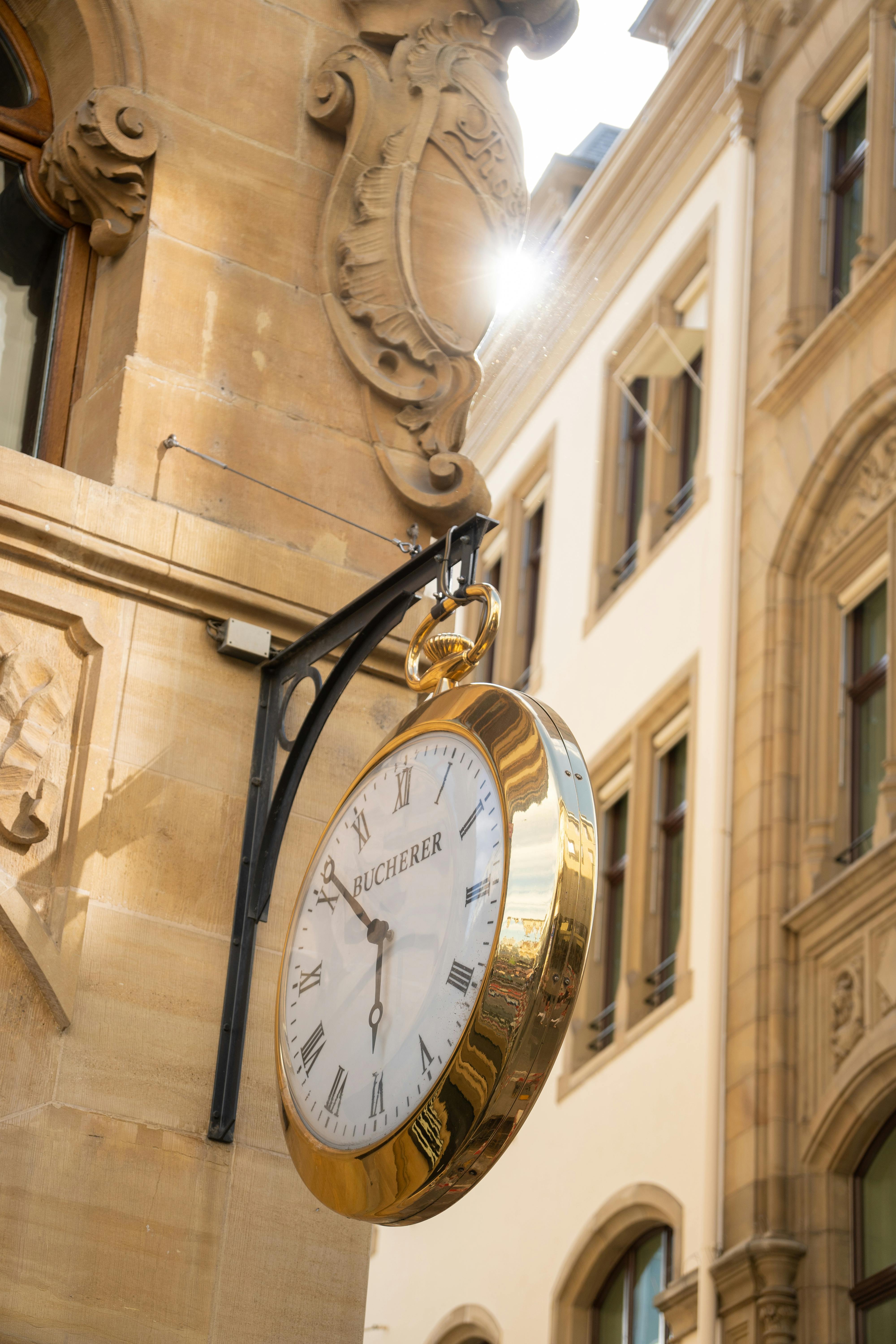 Close-up of a Golden Clock on a Building of the Joailler Bucherer Store ...