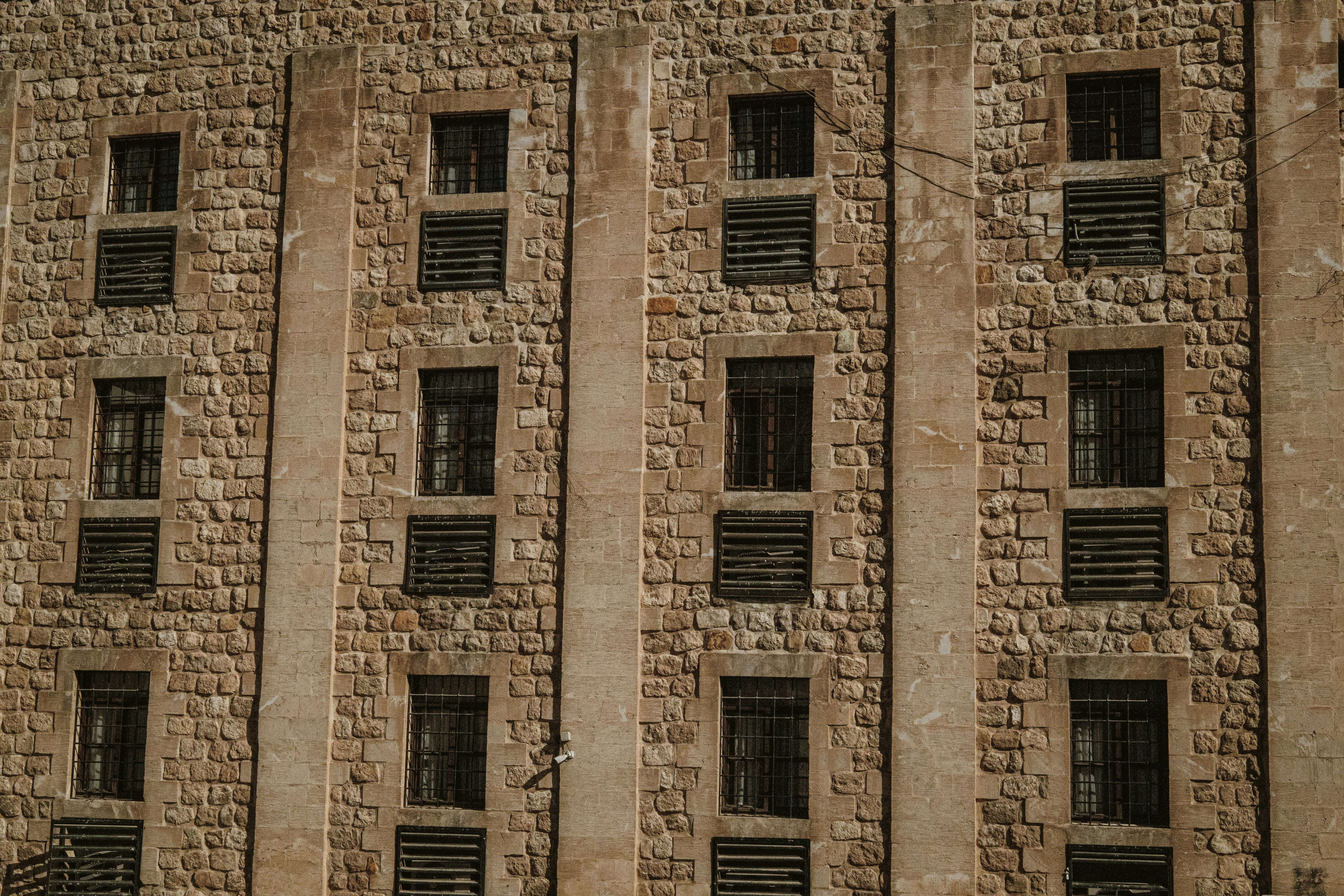 Sunlit, Stone Building Wall · Free Stock Photo