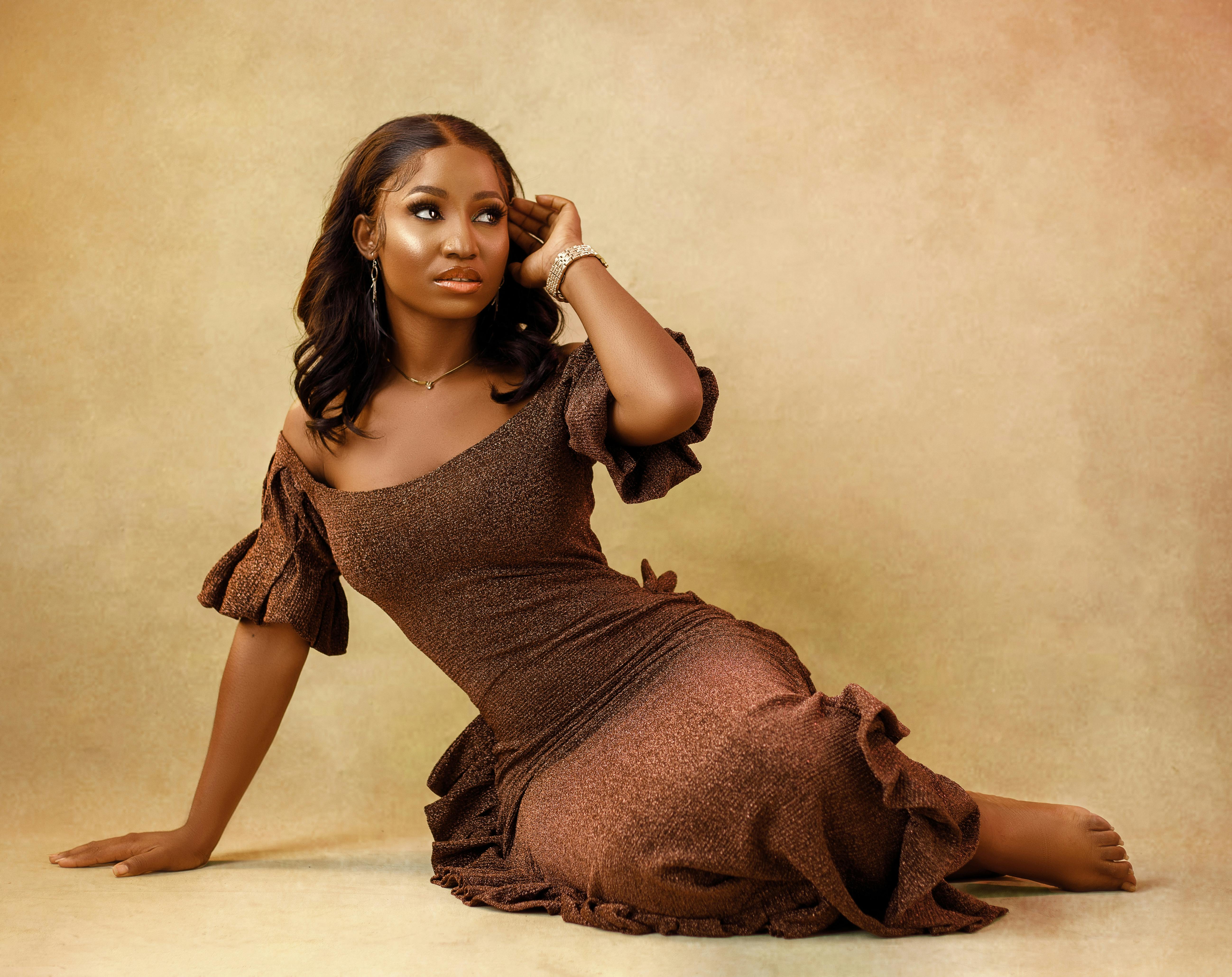 Woman Posing in Brown Dress · Free Stock Photo