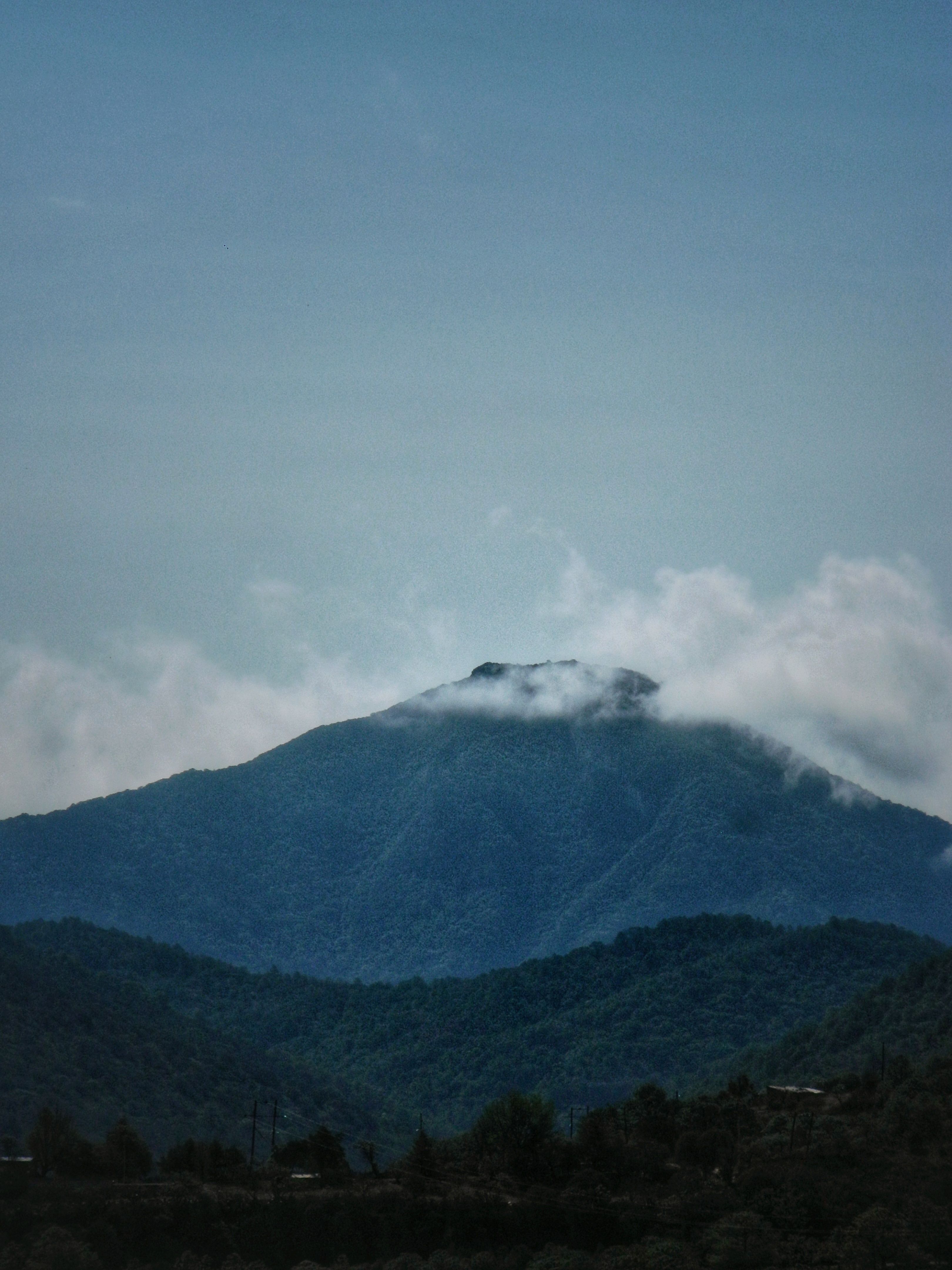 Volcano behind Hills · Free Stock Photo