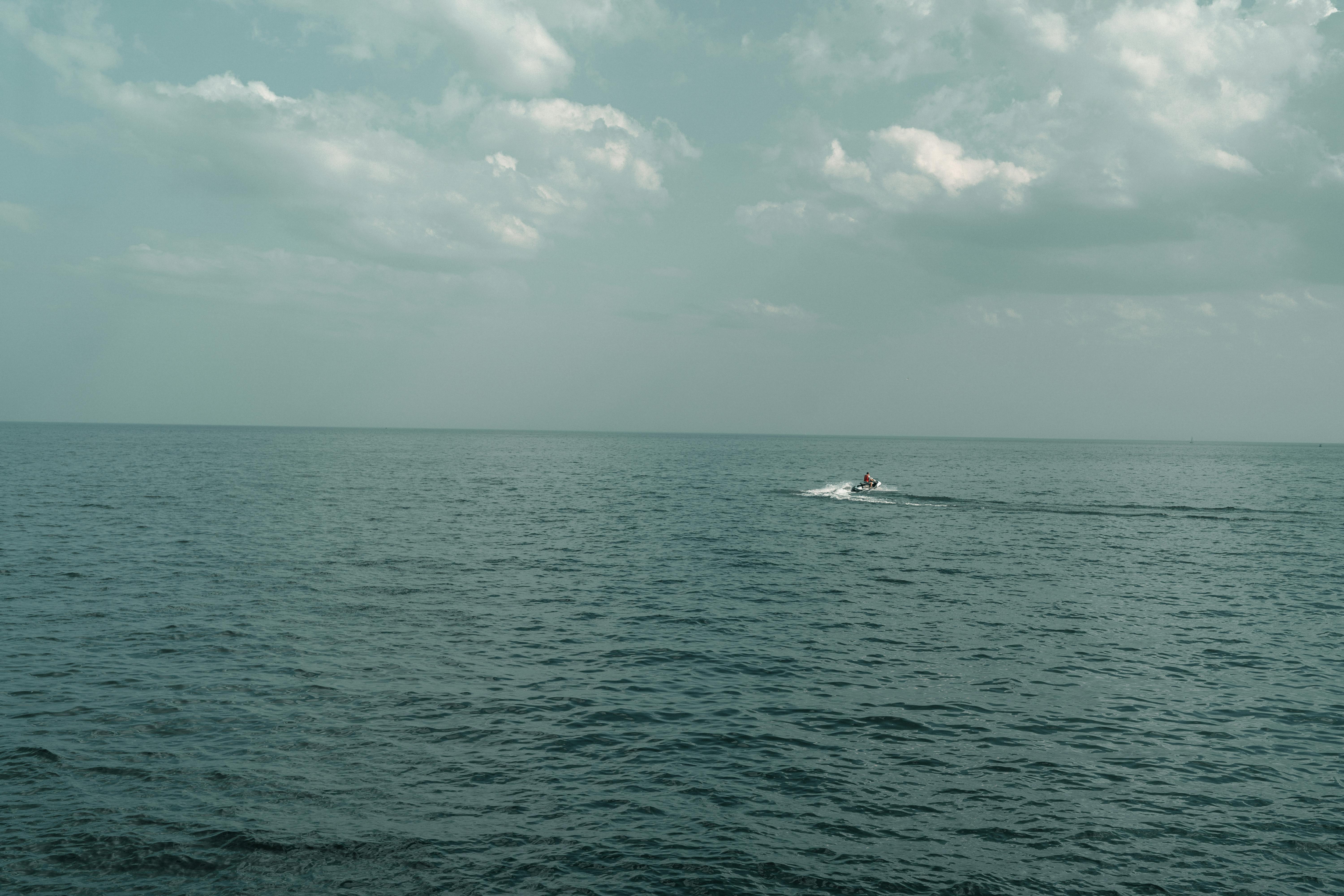 A boat is traveling across the ocean · Free Stock Photo