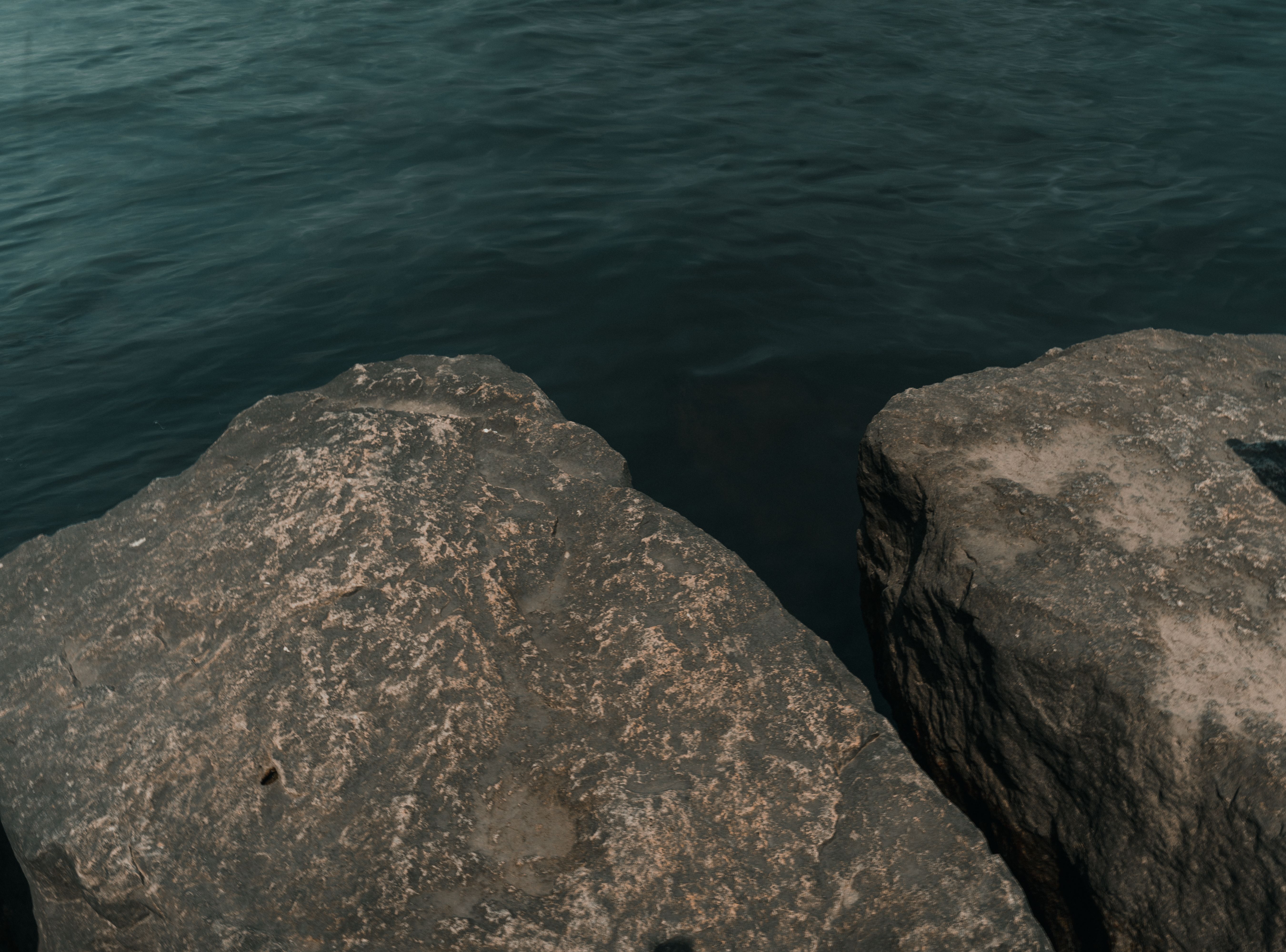 A rock is sitting on top of a large rock · Free Stock Photo